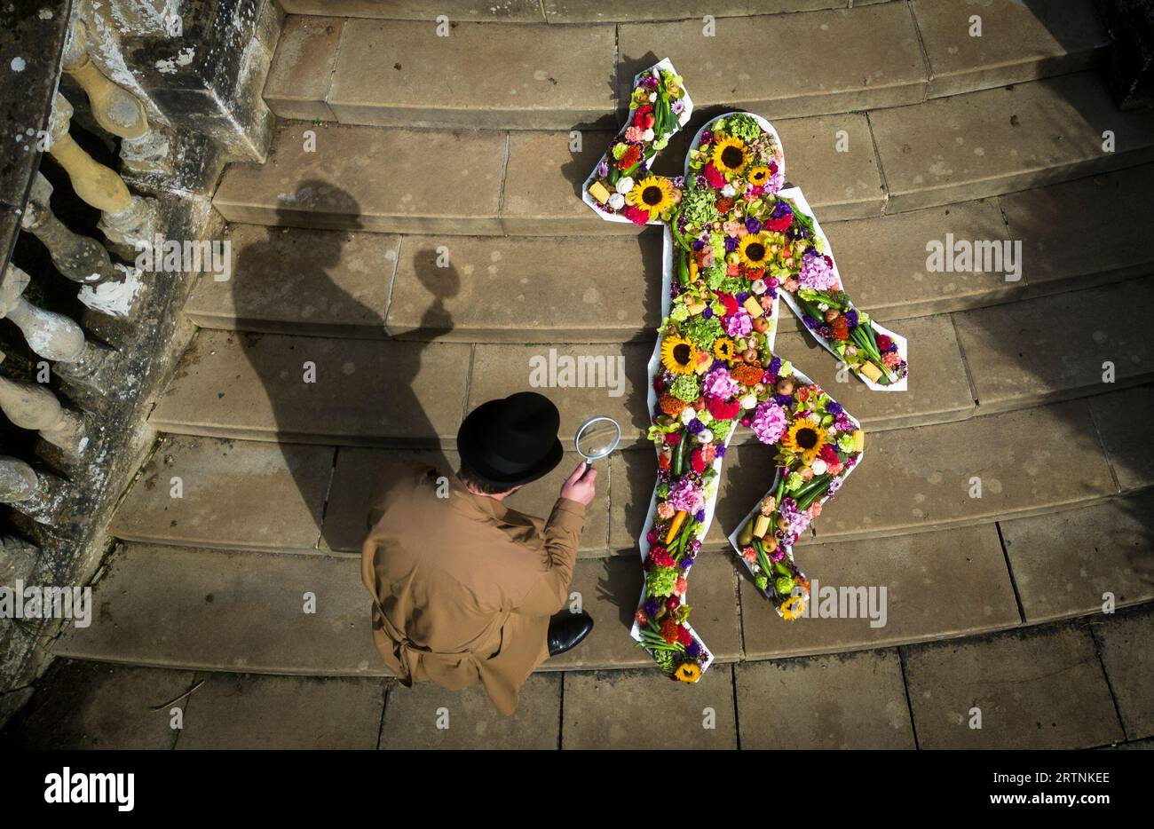 Alexander McDonnell, playing the role of a detective, views a floral ...
