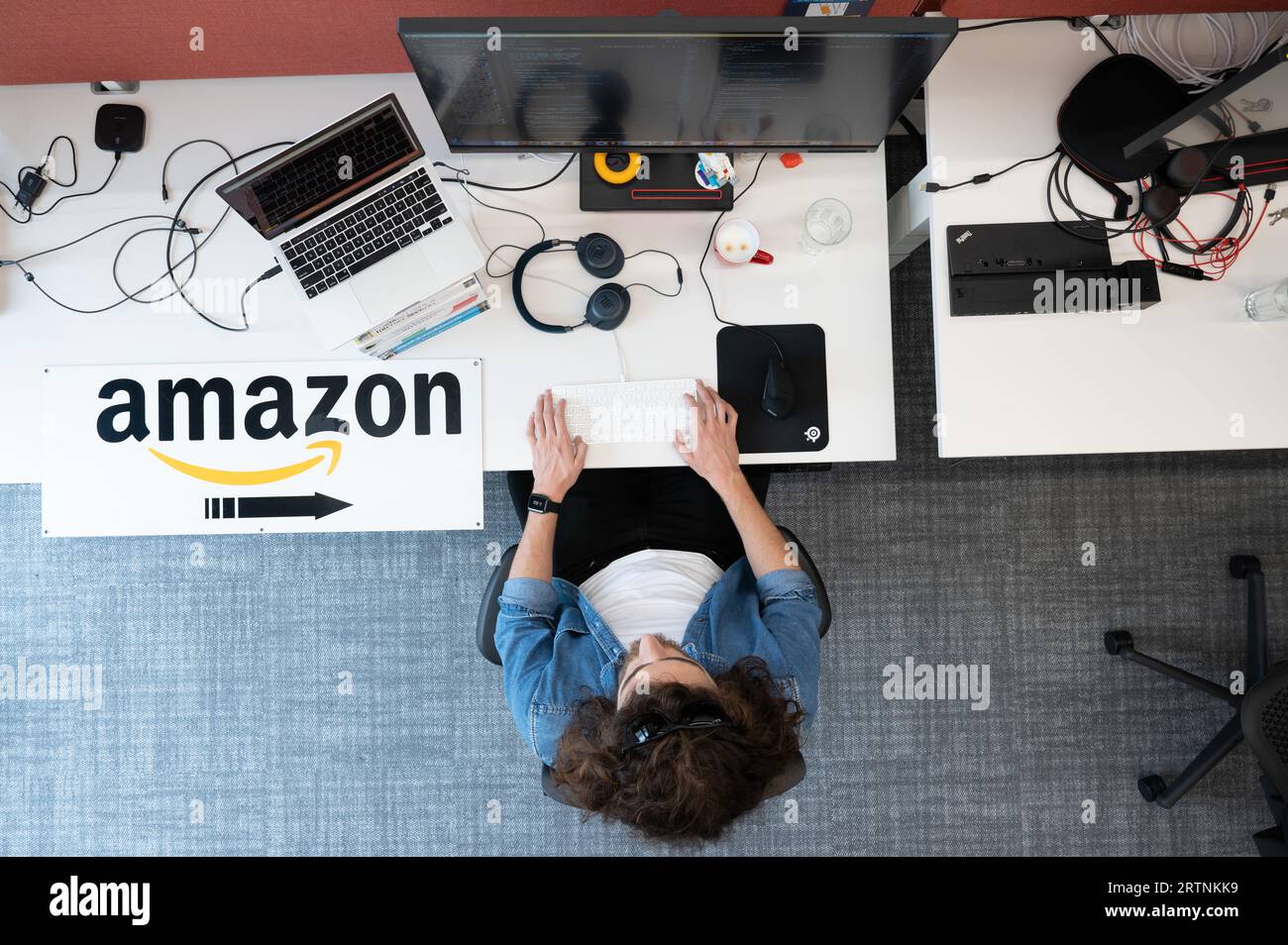 Dresden, Germany. 14th Sep, 2023. An Amazon software developer sits at ...