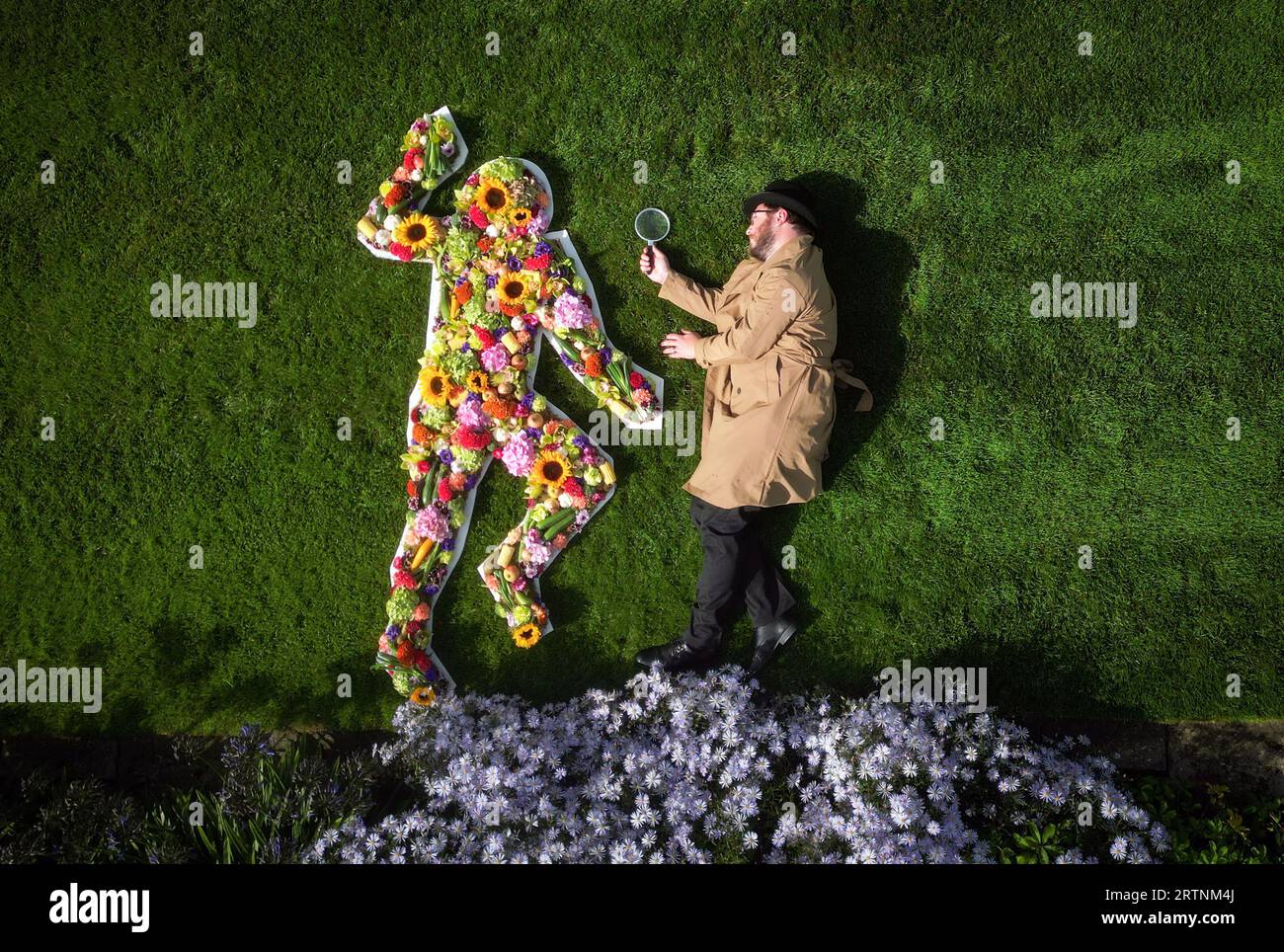 Alexander McDonnell, playing the role of a detective, views a floral ...