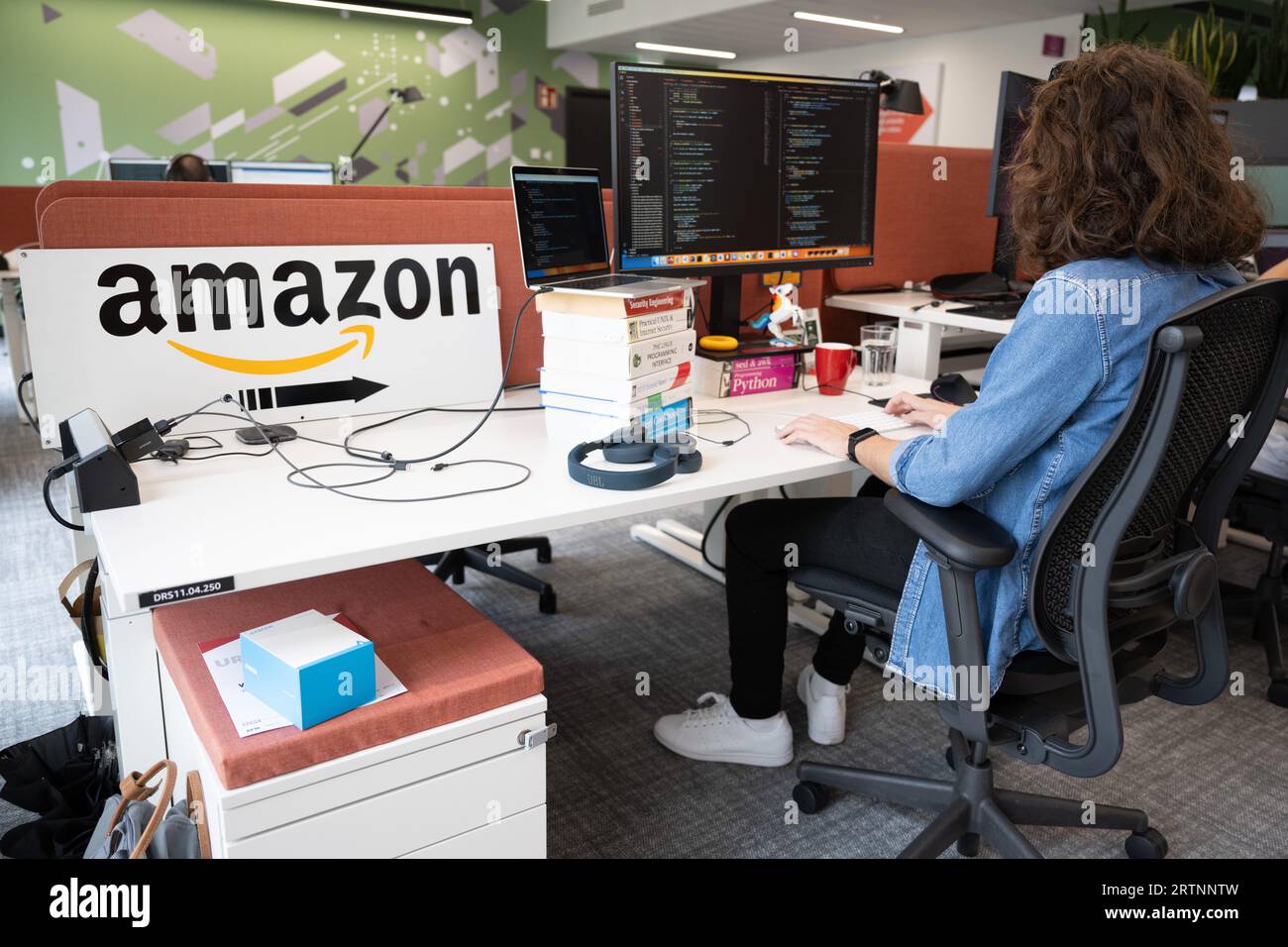 Dresden, Germany. 14th Sep, 2023. An Amazon software developer sits at ...