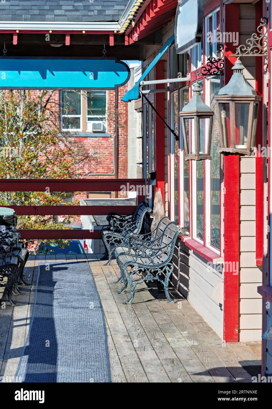 Wooden deck with benches in front of a street shop entrance Stock Photo ...