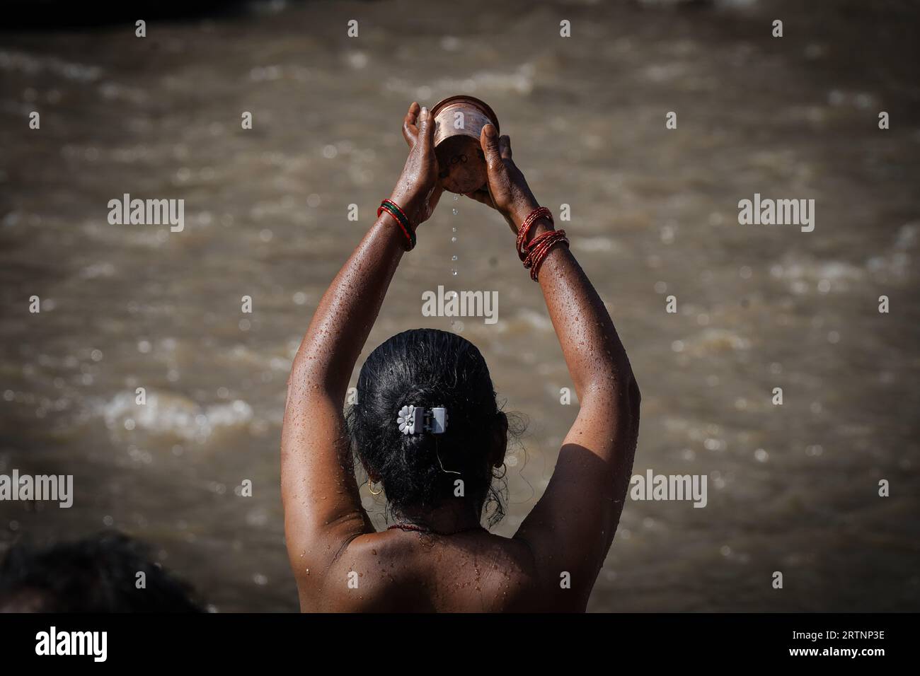 Kathmandu, Nepal. 14th Sep, 2023. A devotee offers holy water for ...
