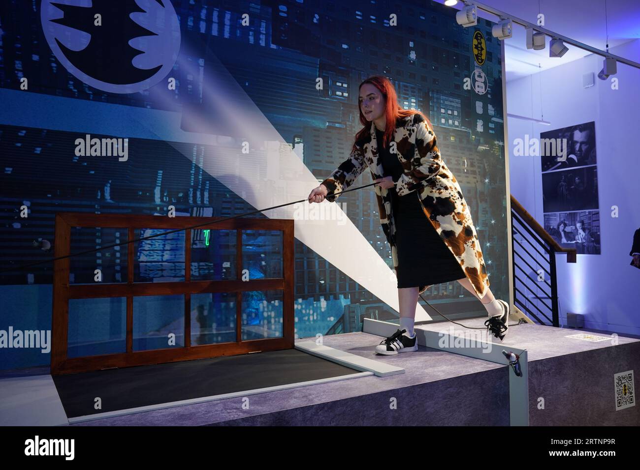 A woman takes part in an interactive experience at the DC Comics and ...