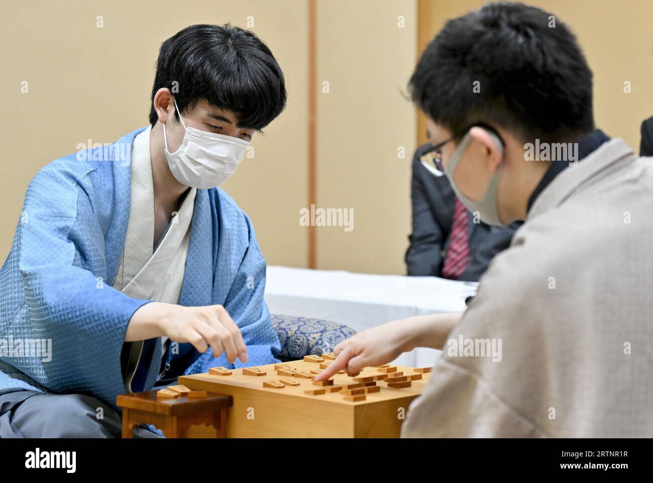 Sota Fujii (L), holder of seven of shogi's eight titles, reviews his ...