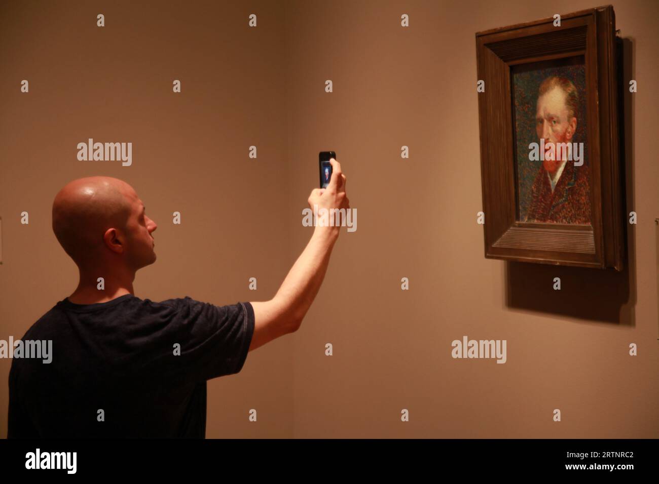 Visitor is photographing a self portrait by Vincent van Gogh with his ...