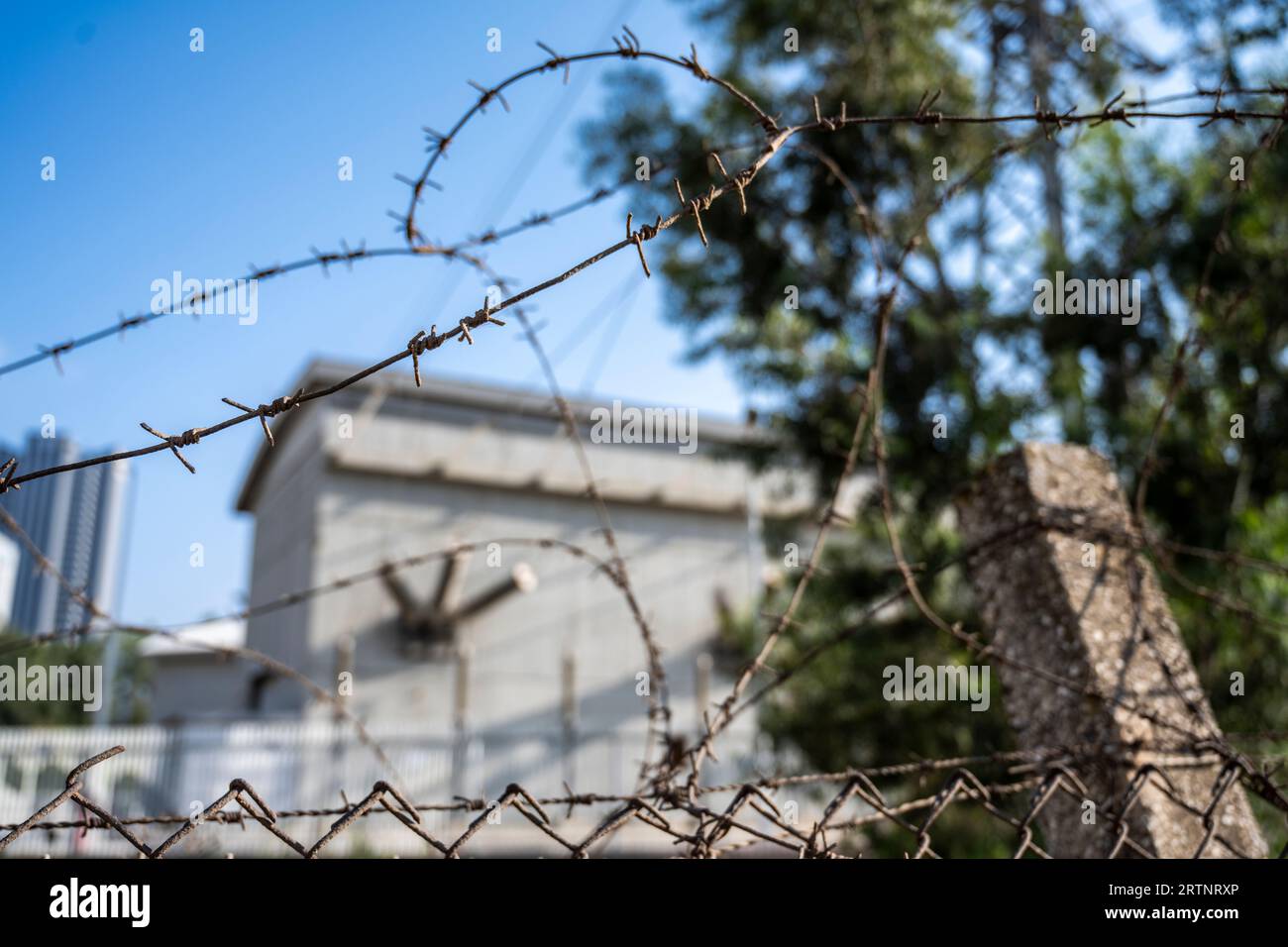 Concrete building of an Electric sub-station surrounded by a barbed ...
