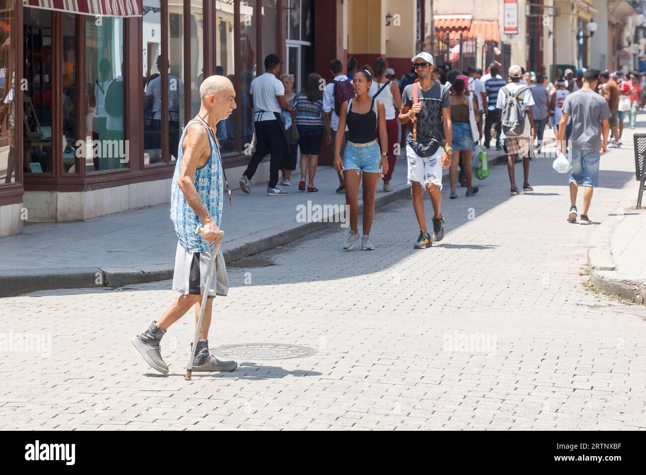 Havana, Cuba - August 30, 2023: A slim Cuban man walks in a cobblestone ...