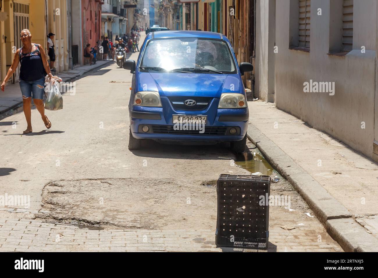 Havana, Cuba - August 30, 2023: A person walks in a cobblestone street ...