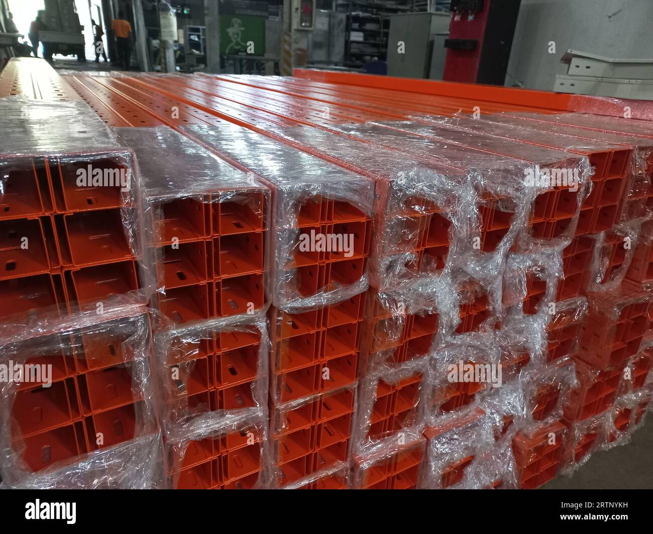 A large quantity of orange support beams for commercial pallet racks in ...