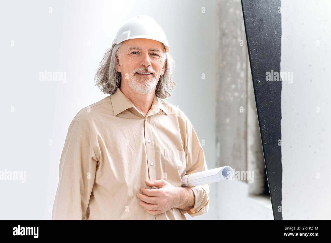 Positive caucasian elderly gray haired male architect builder, civil ...
