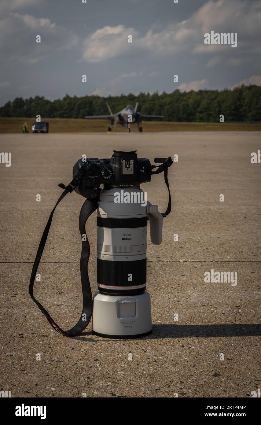 A mirrorless digital camera with a super zoom lens standing up at an ...