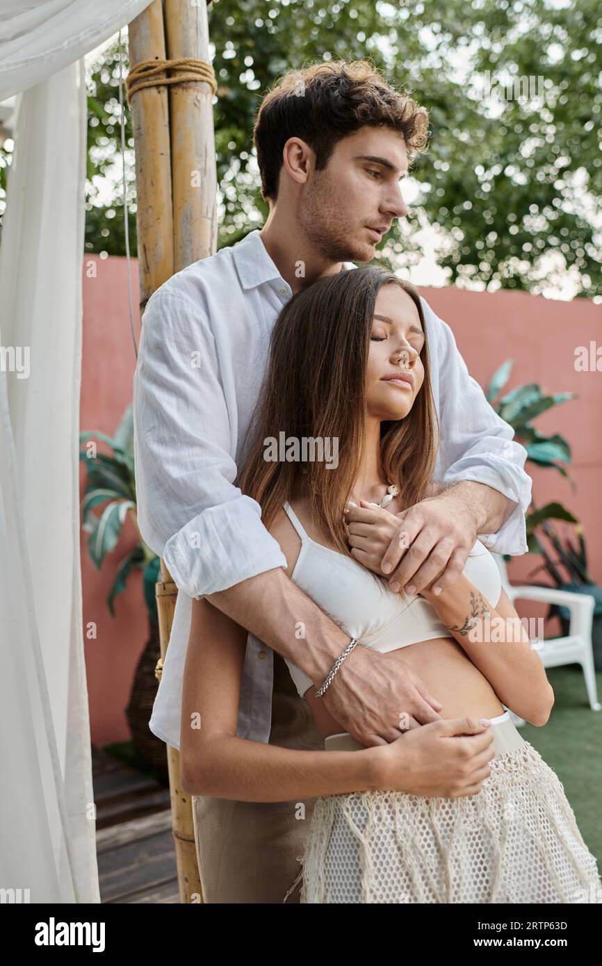 handsome man and beautiful woman in white summer attire standing ...