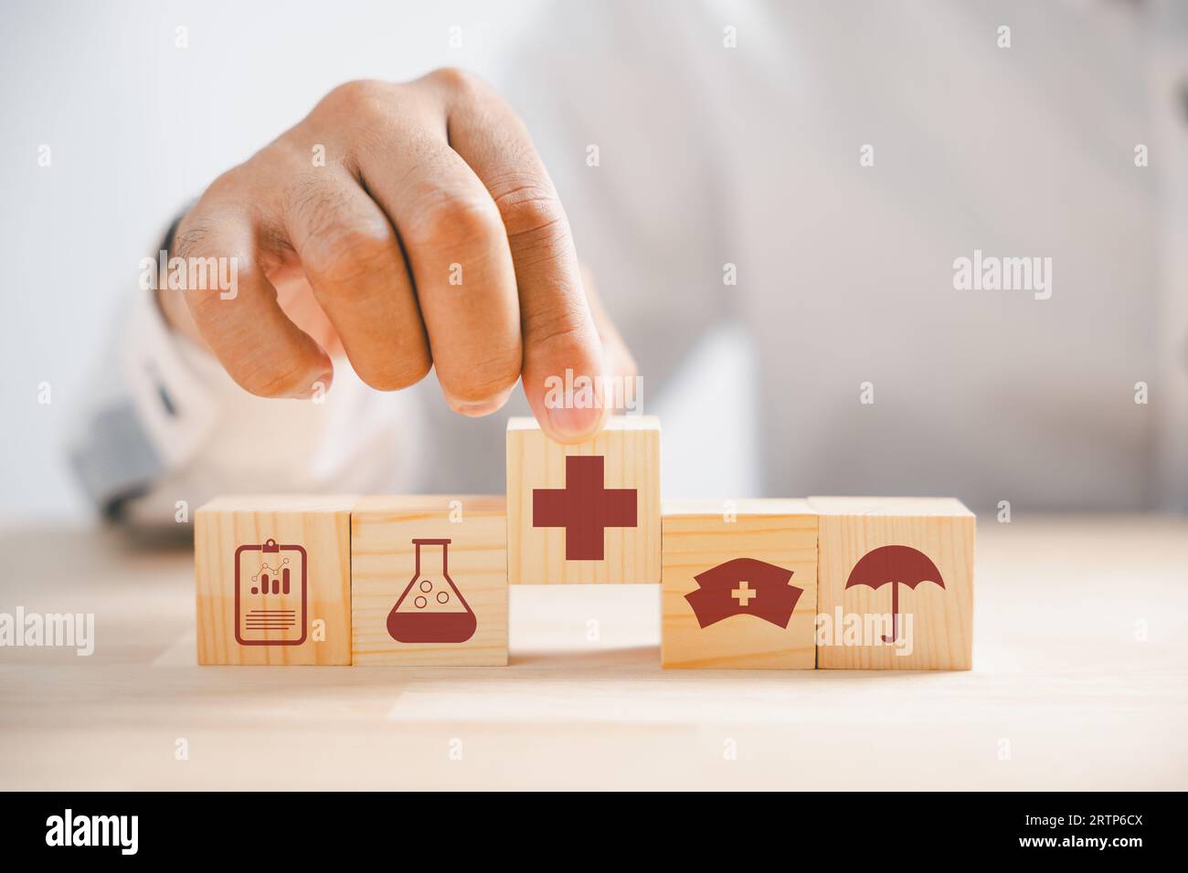 Hand hold wooden block with icon healthcare medical Stock Photo - Alamy