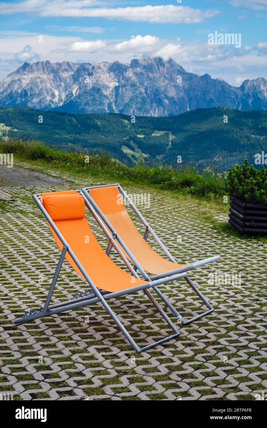 Two empty deck chairs at a mountaintop restaurant, Schmittenhohe ...