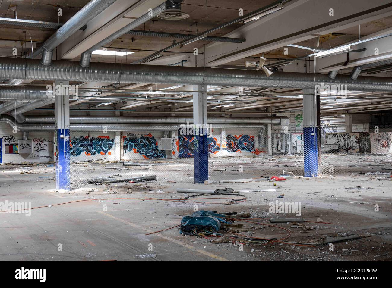 Abandoned and vandalized industrial building with graffitis on the wall ...