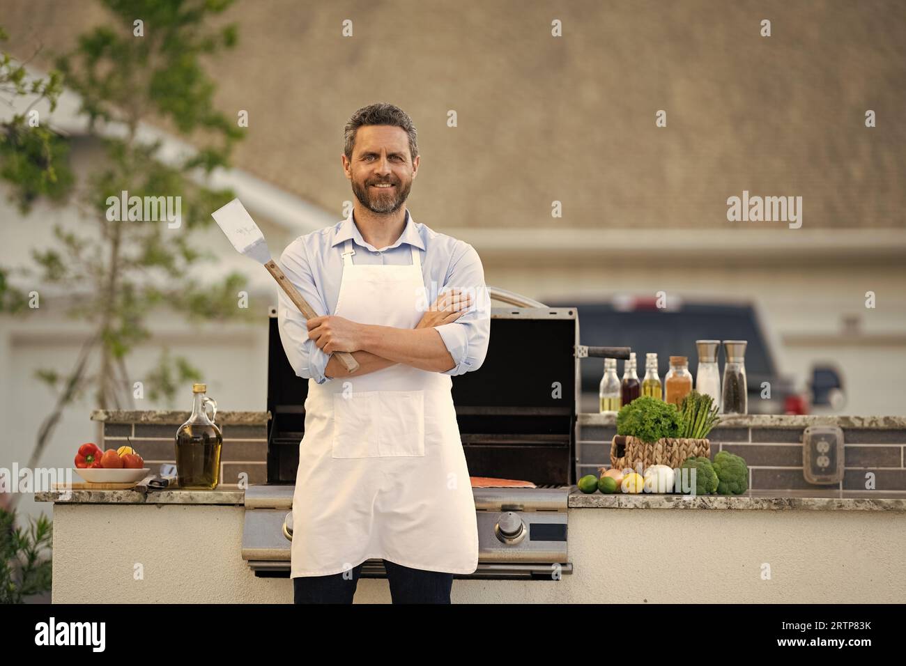 chef man at barbecue and grill hold utensil, copy space. chef man at ...