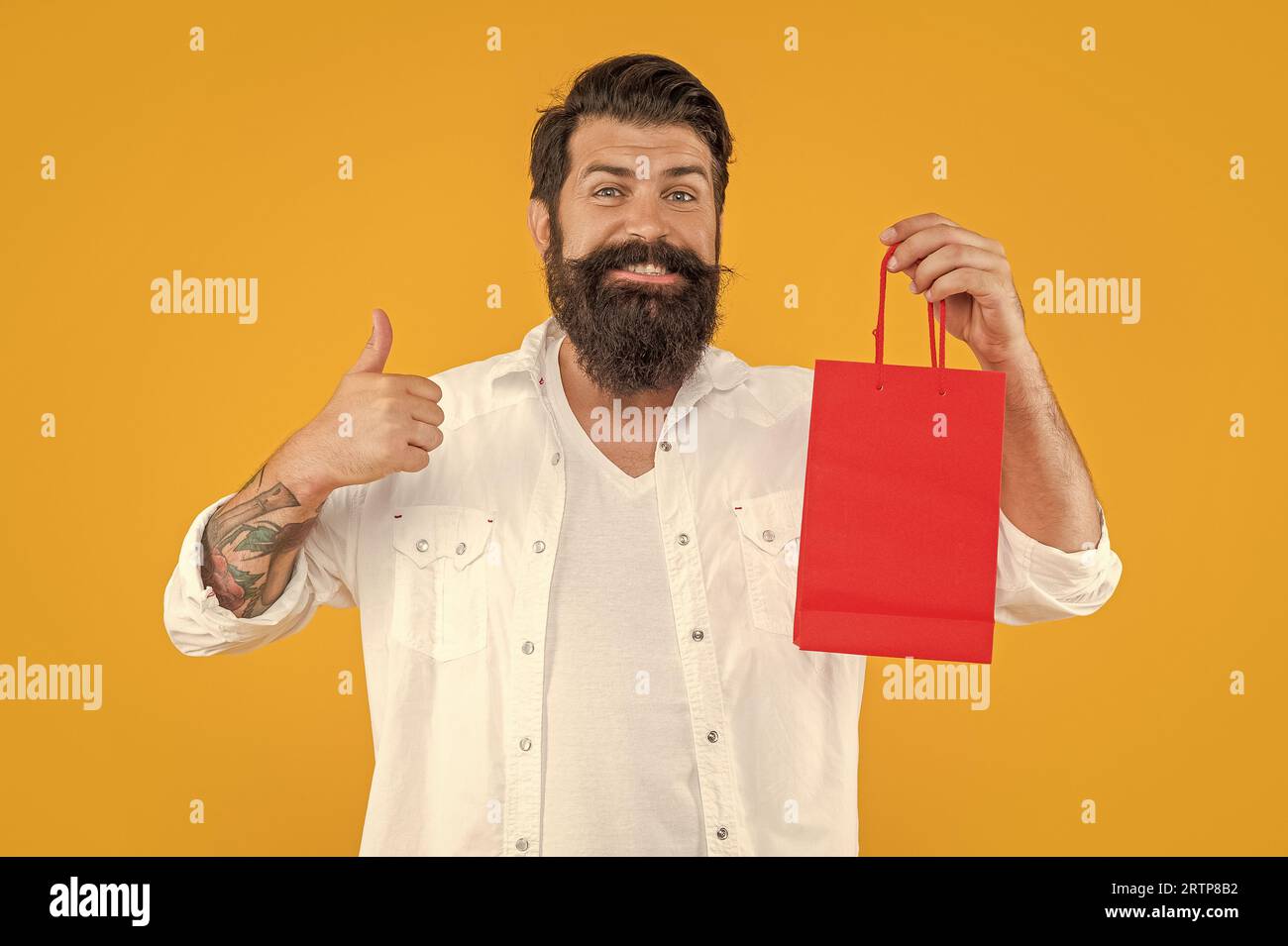 shopper man at shopping on background, thumb up. photo of shopper man ...