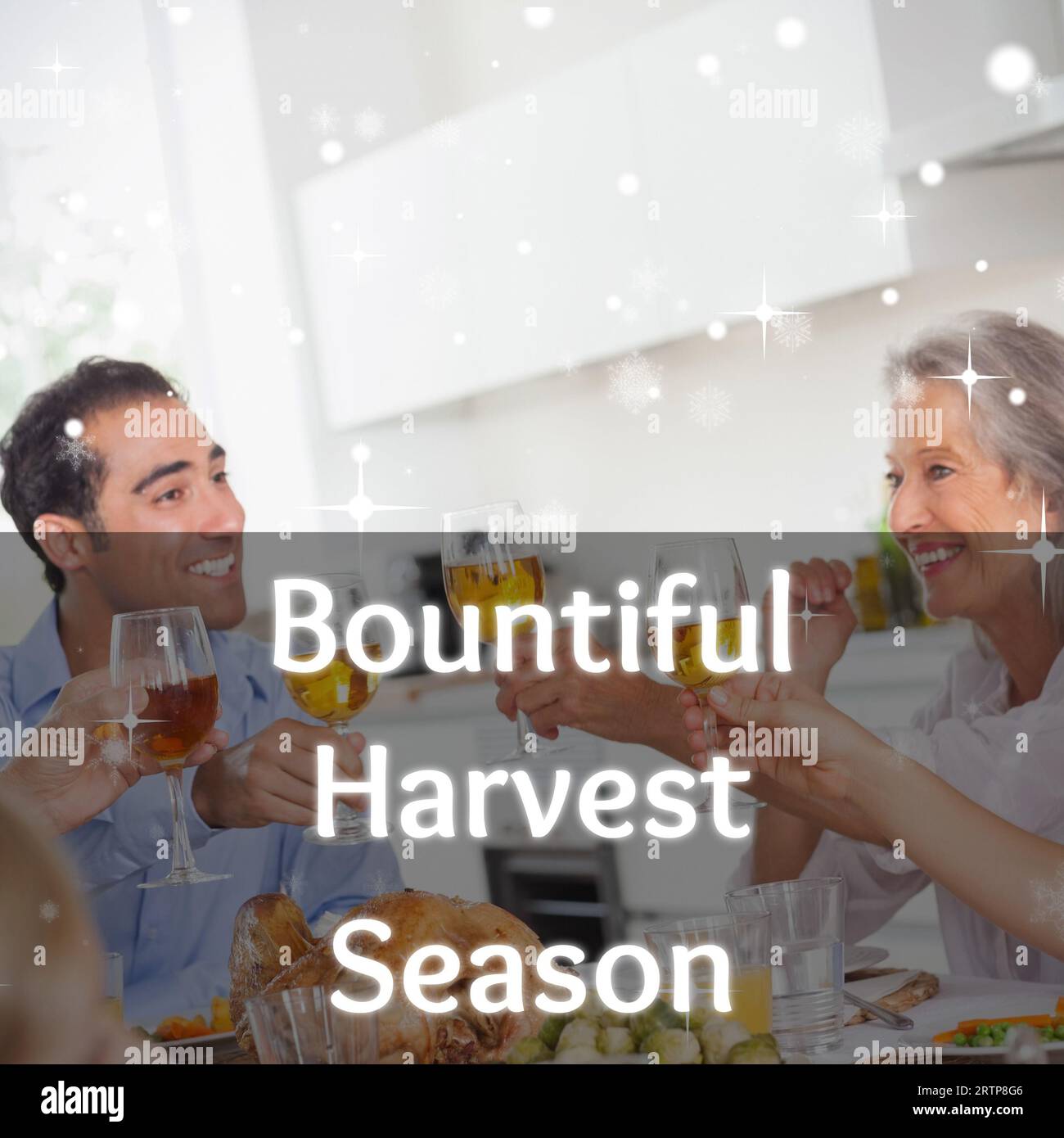 Bountiful harvest season text over happy caucasian family toasting at ...