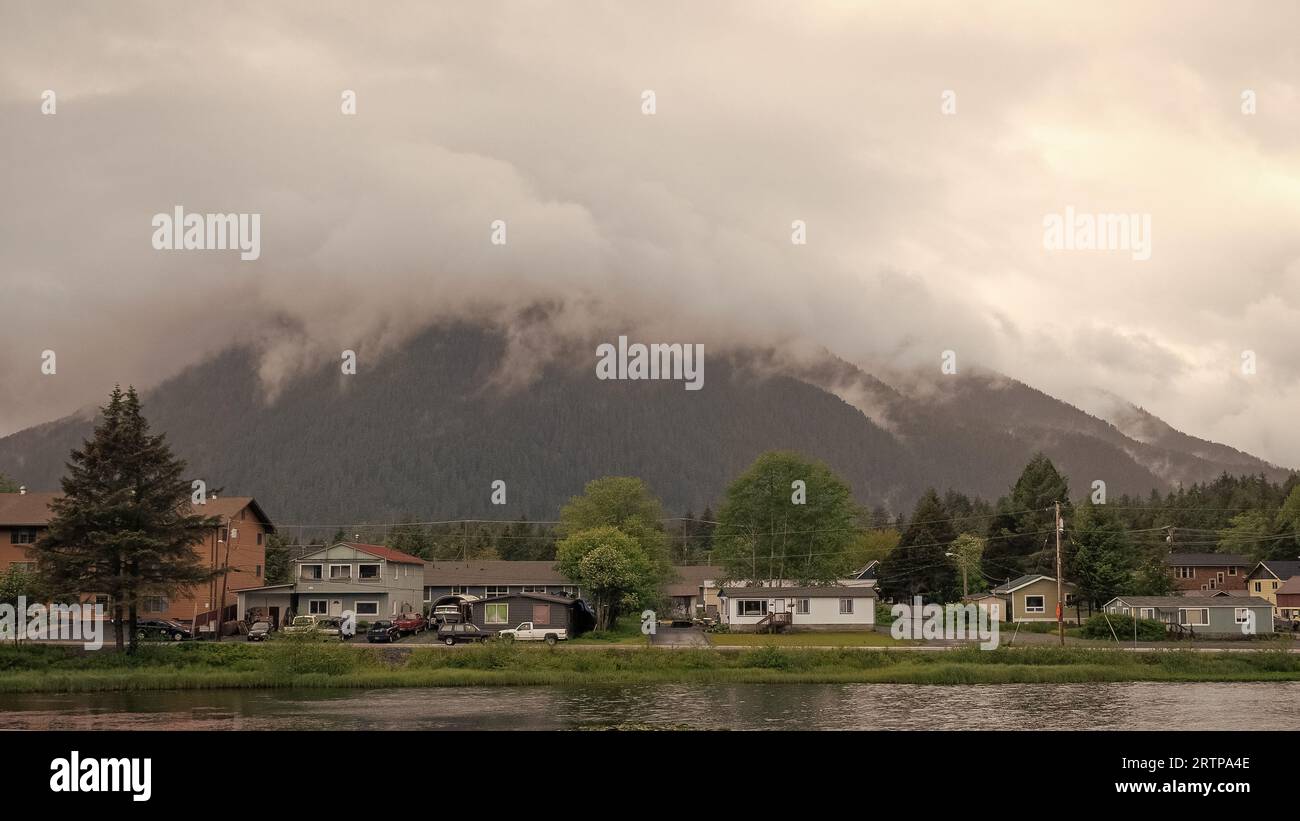 Mountain village on river bank. Misty mountain landscape. Scenic ...