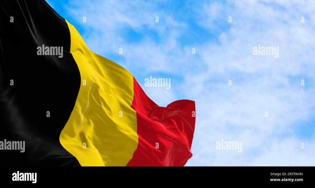 Close-up of the national flag of Belgium waving on a clear day. Three ...