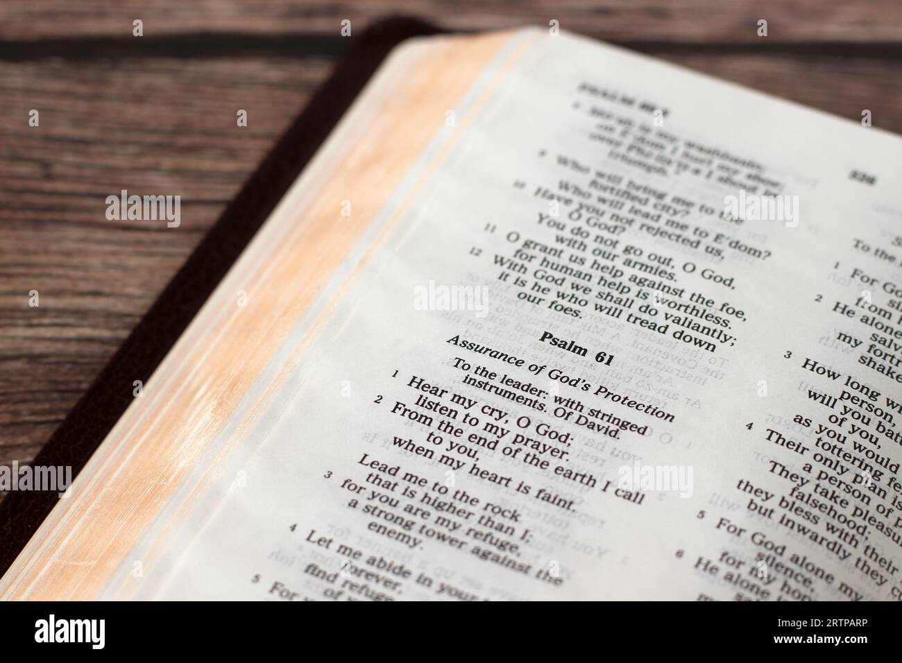 Assurance of God's protection, psalm 61 in open holy bible book on wooden table. Christian ...