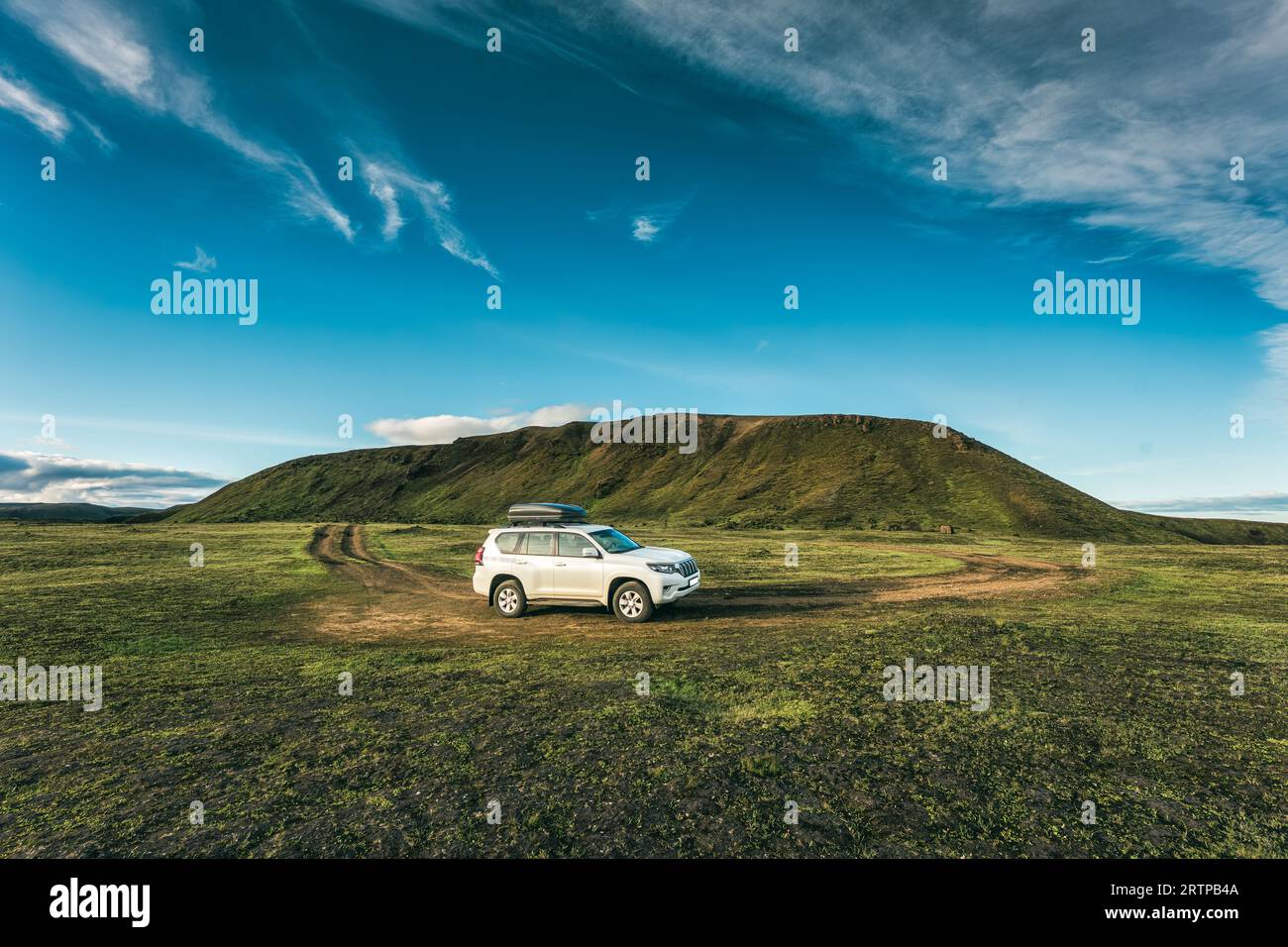 4wd car parked on remote wilderness and mossy hill in summer at ...