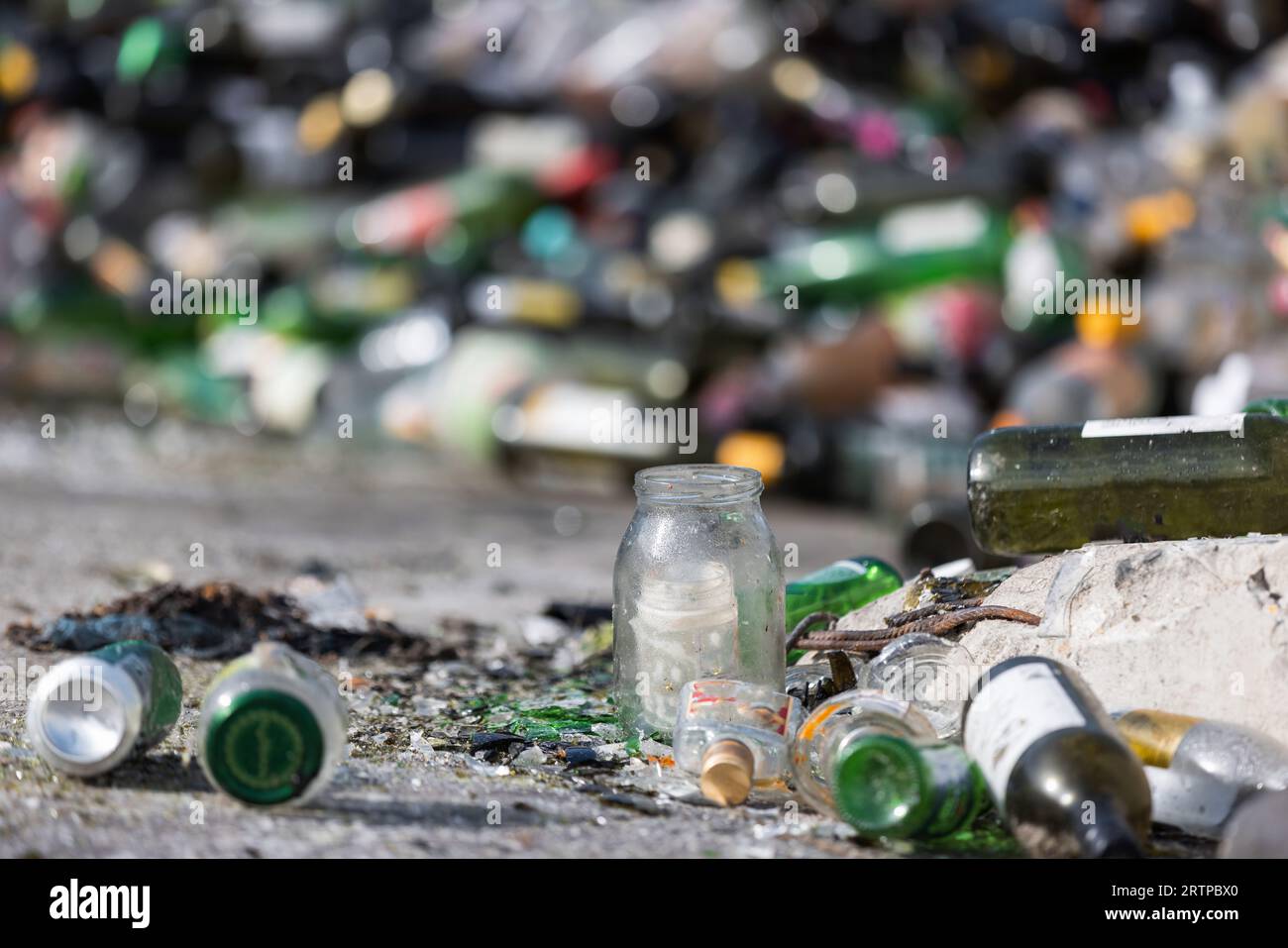 Pile of waste glass bottles, close up view. Consumption, recycling, and ...