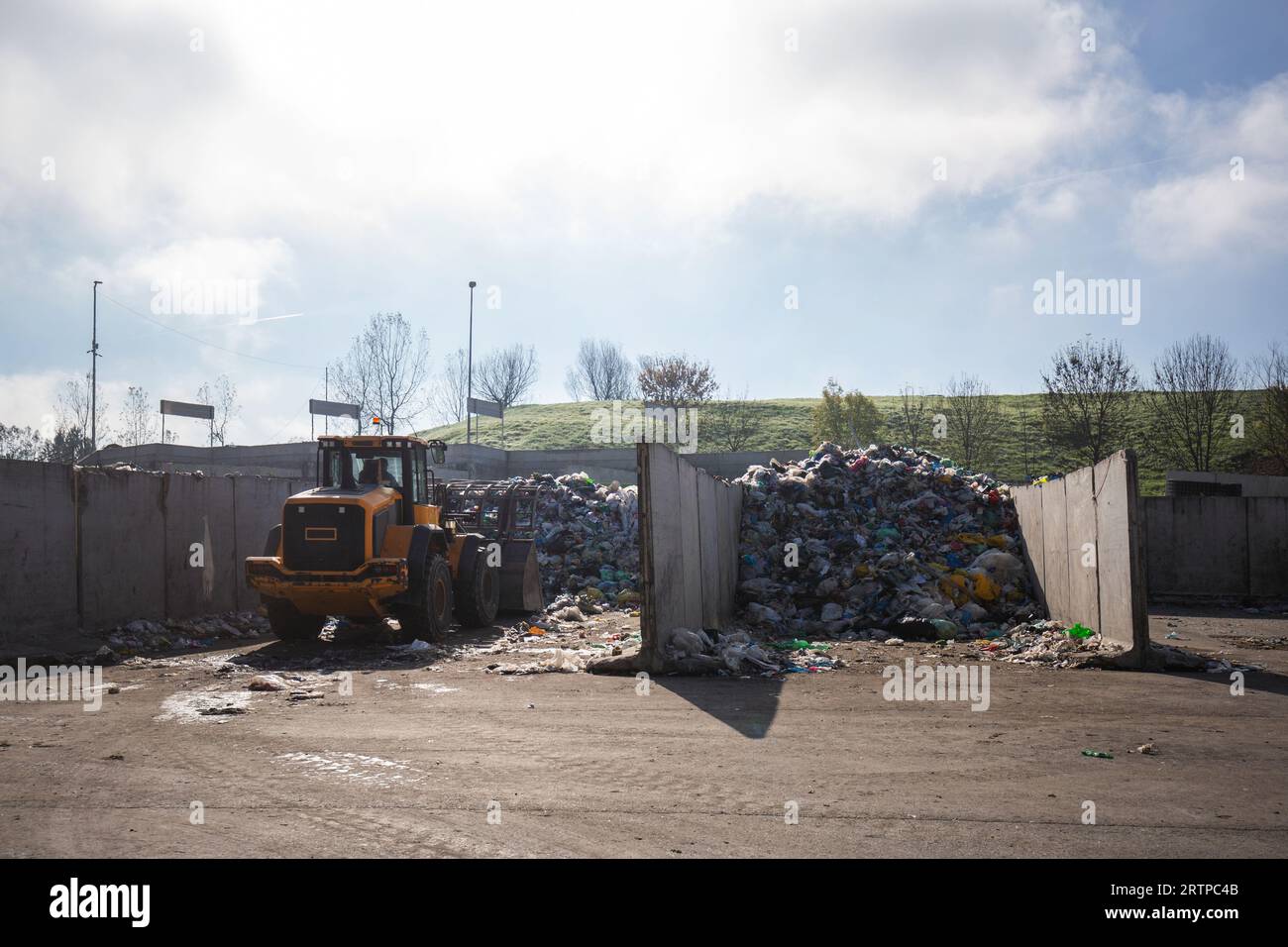 Front loader with scrap handling grapple bucket moving forward and ...