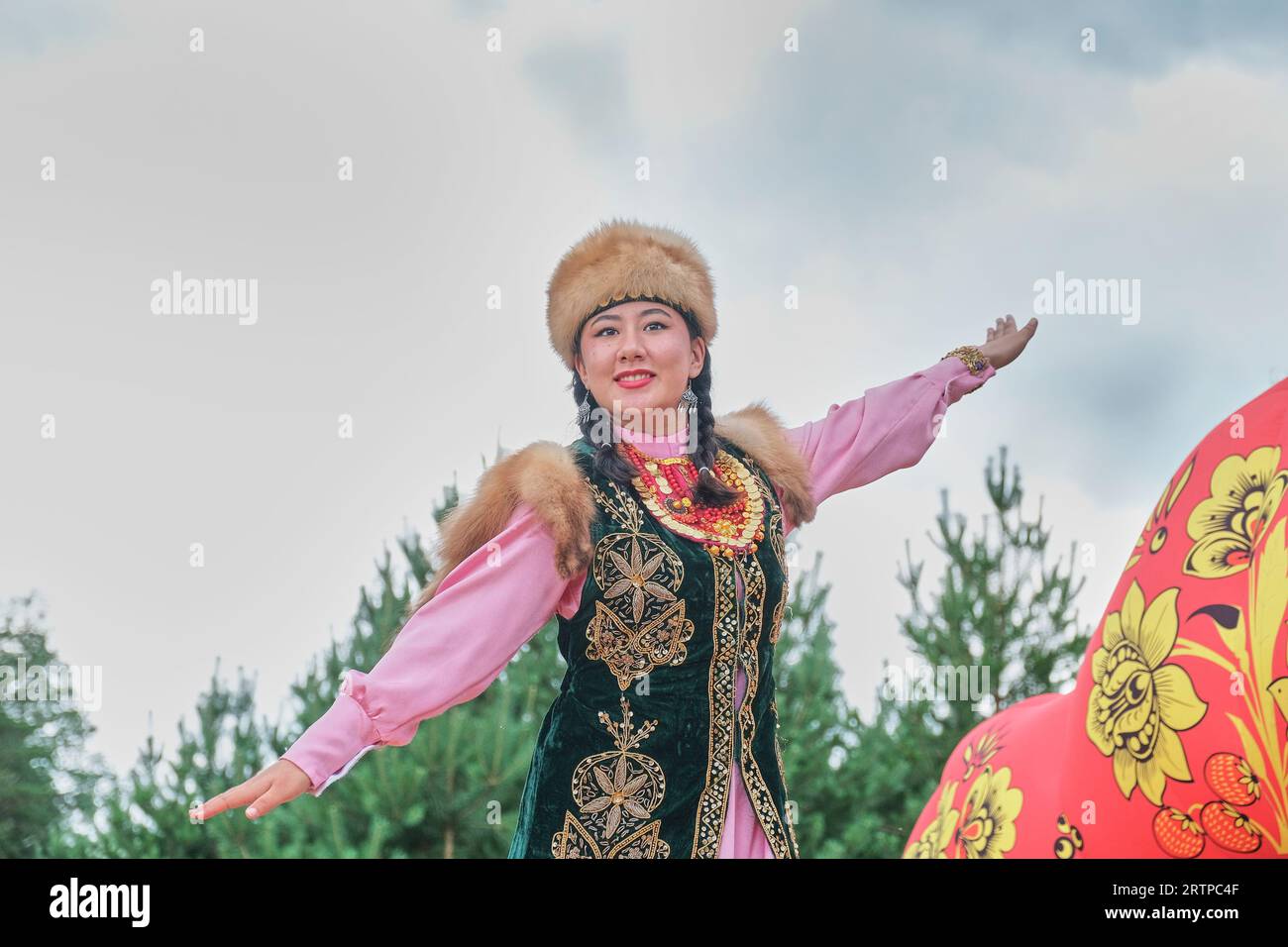 Close up of attractive smiling Asian girl in fur headdress and ...