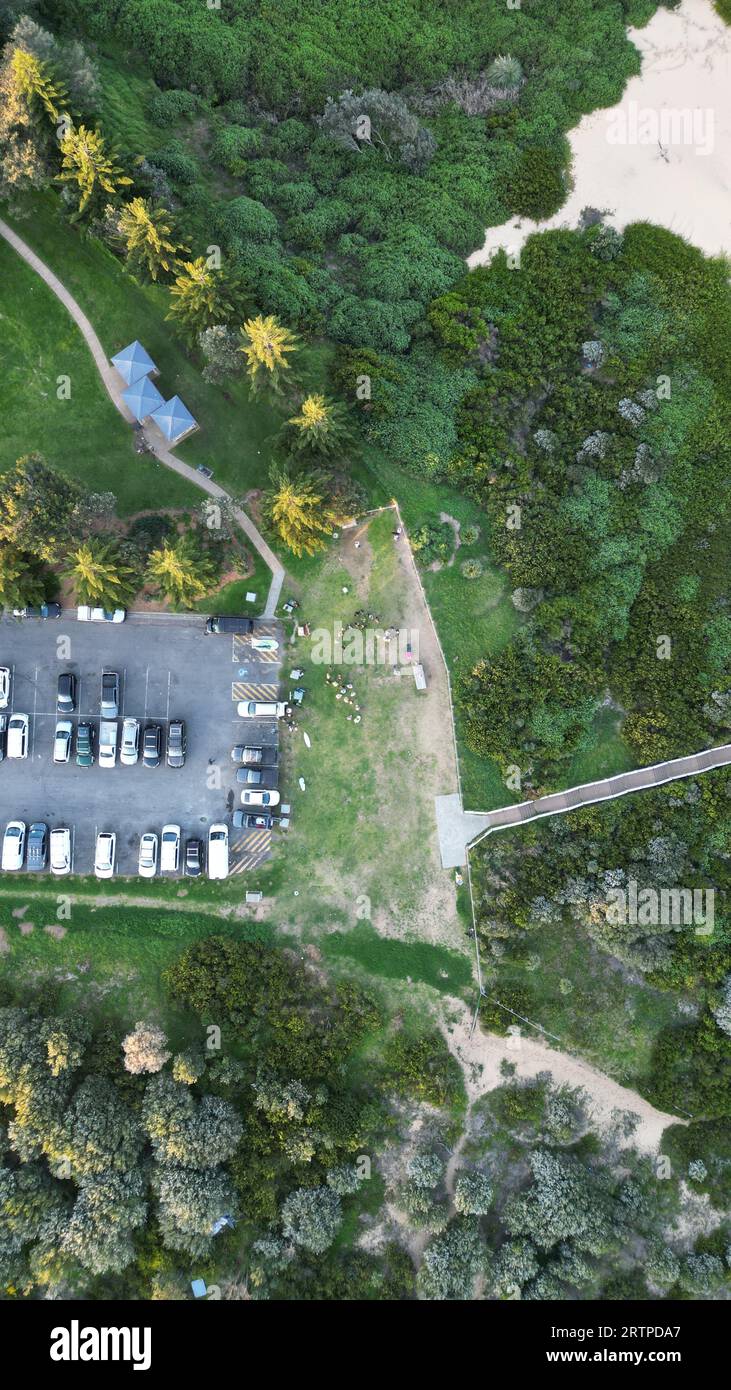 An aerial view of a bustling car park filled with an array of vehicles ...