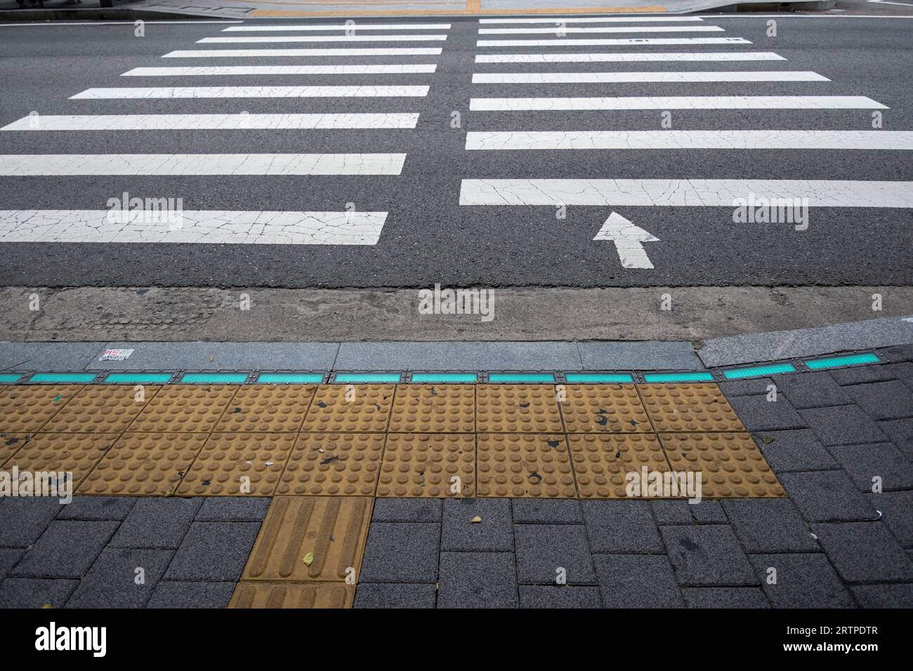 Street crossing in Seoul. The green light on the floor indicates that ...