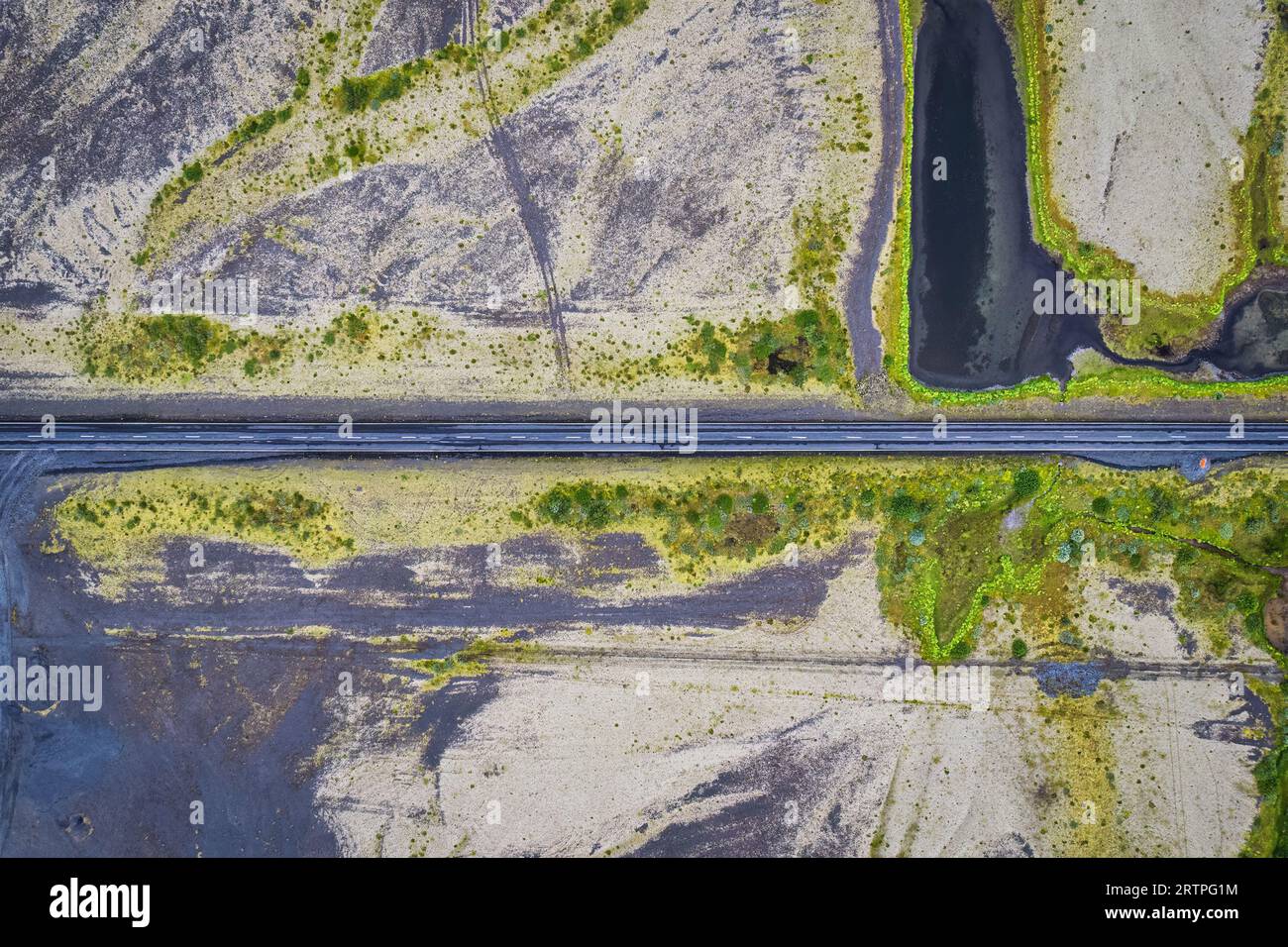 Top view of asphalt road cut through mossy remote wilderness in rural ...
