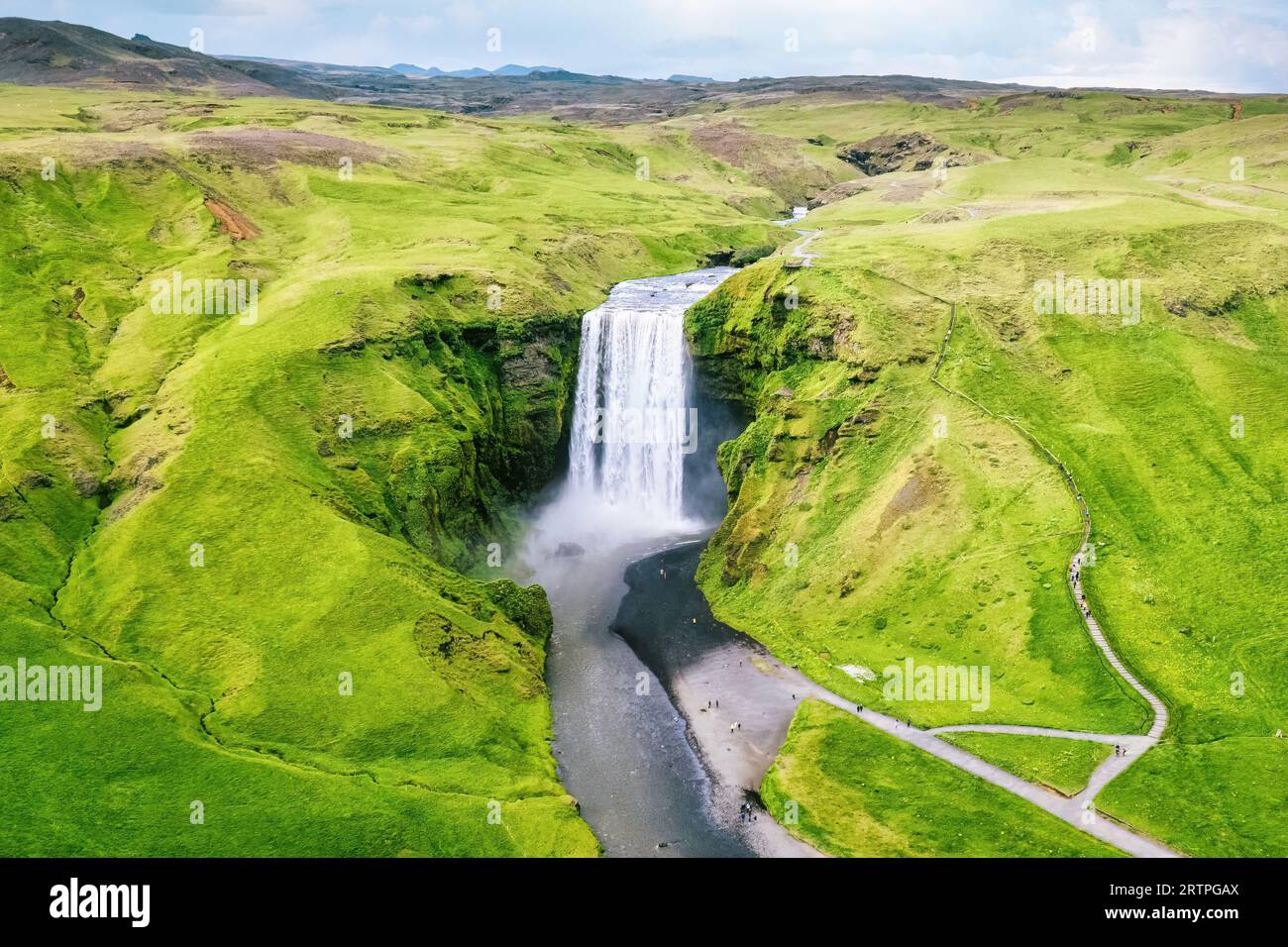 Aerial view of majestic Skogafoss waterfall flowing from cliff ...