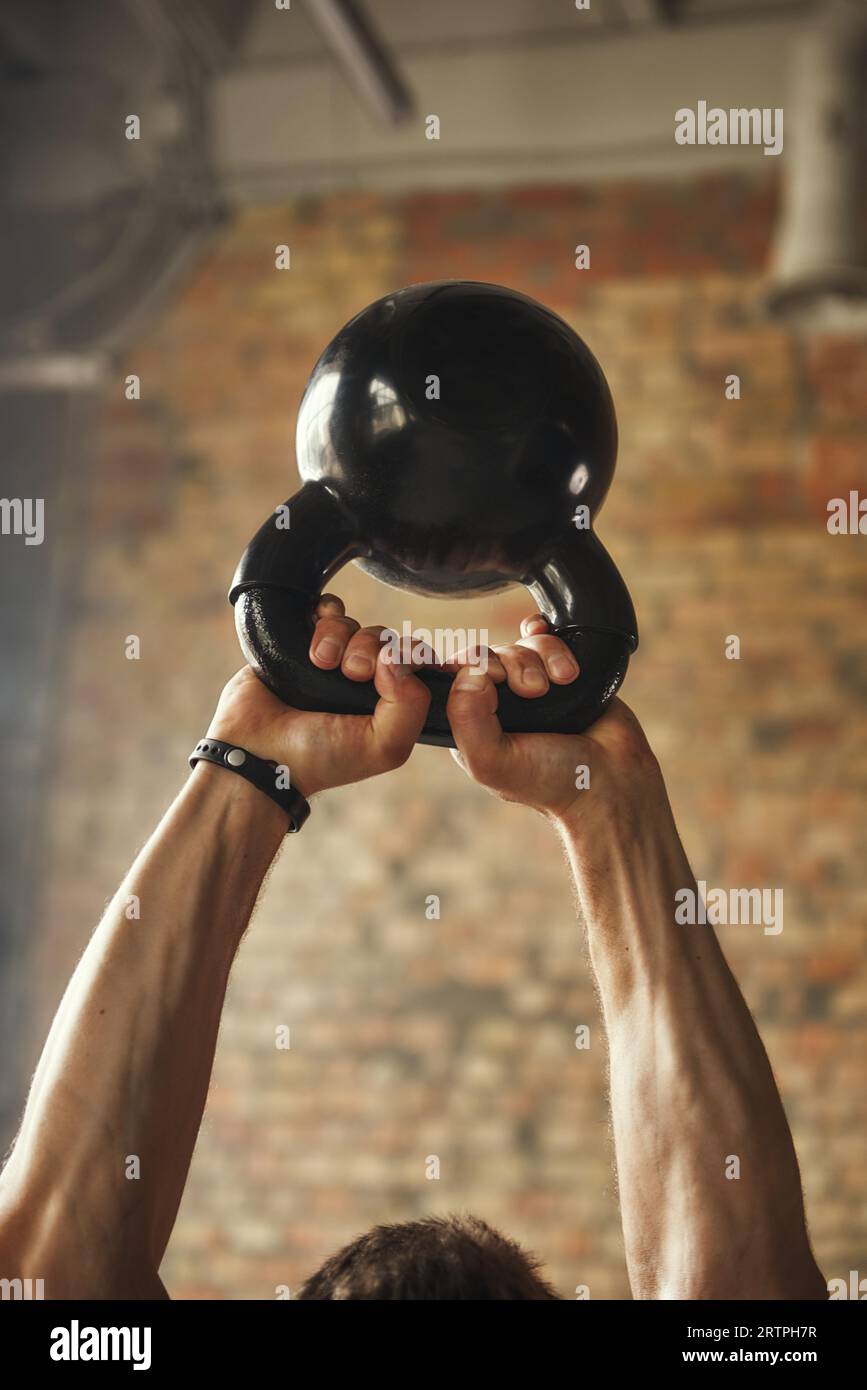 Cropped photo of strong man hands holding big dumbbell under his head ...