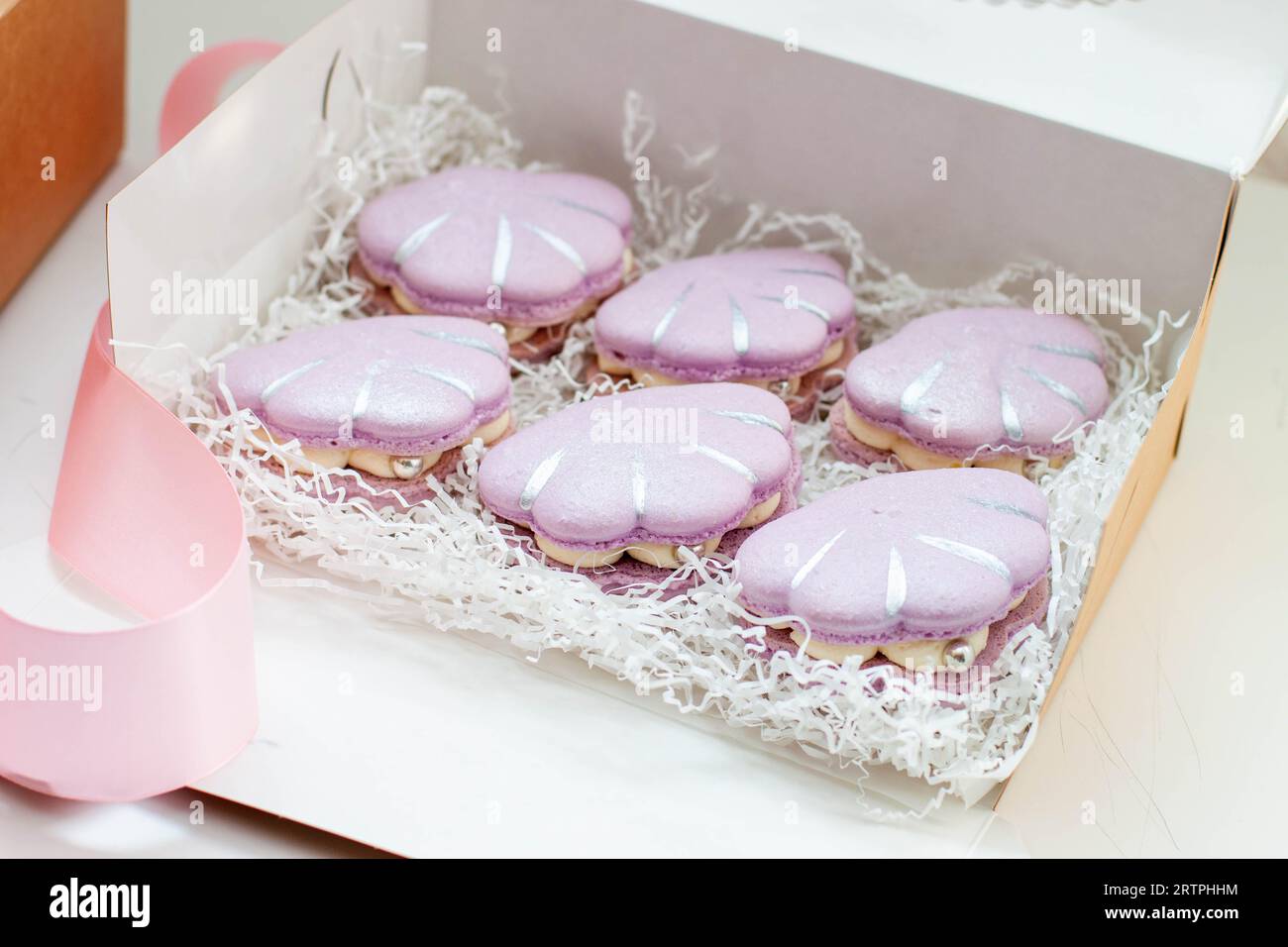 Sea shells shaped french macarons in soft pastel purple color in the ...