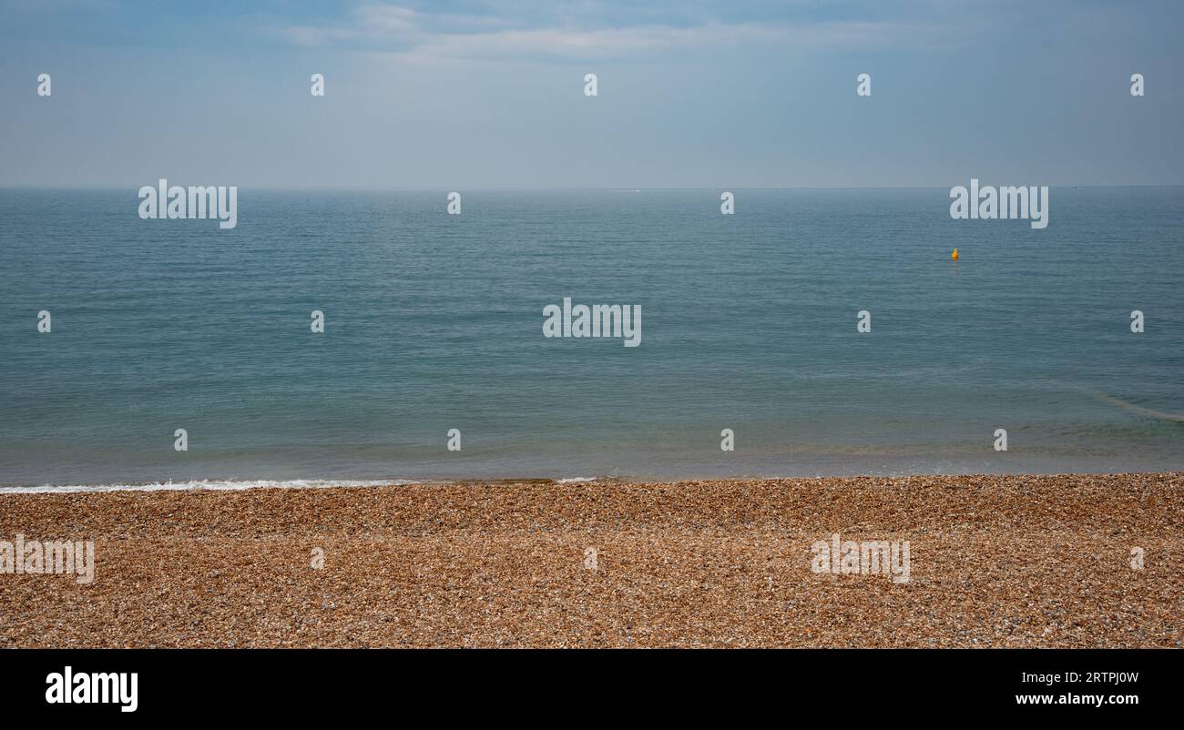 Pebble beach coastline calm ocean. Nature background Stock Photo - Alamy