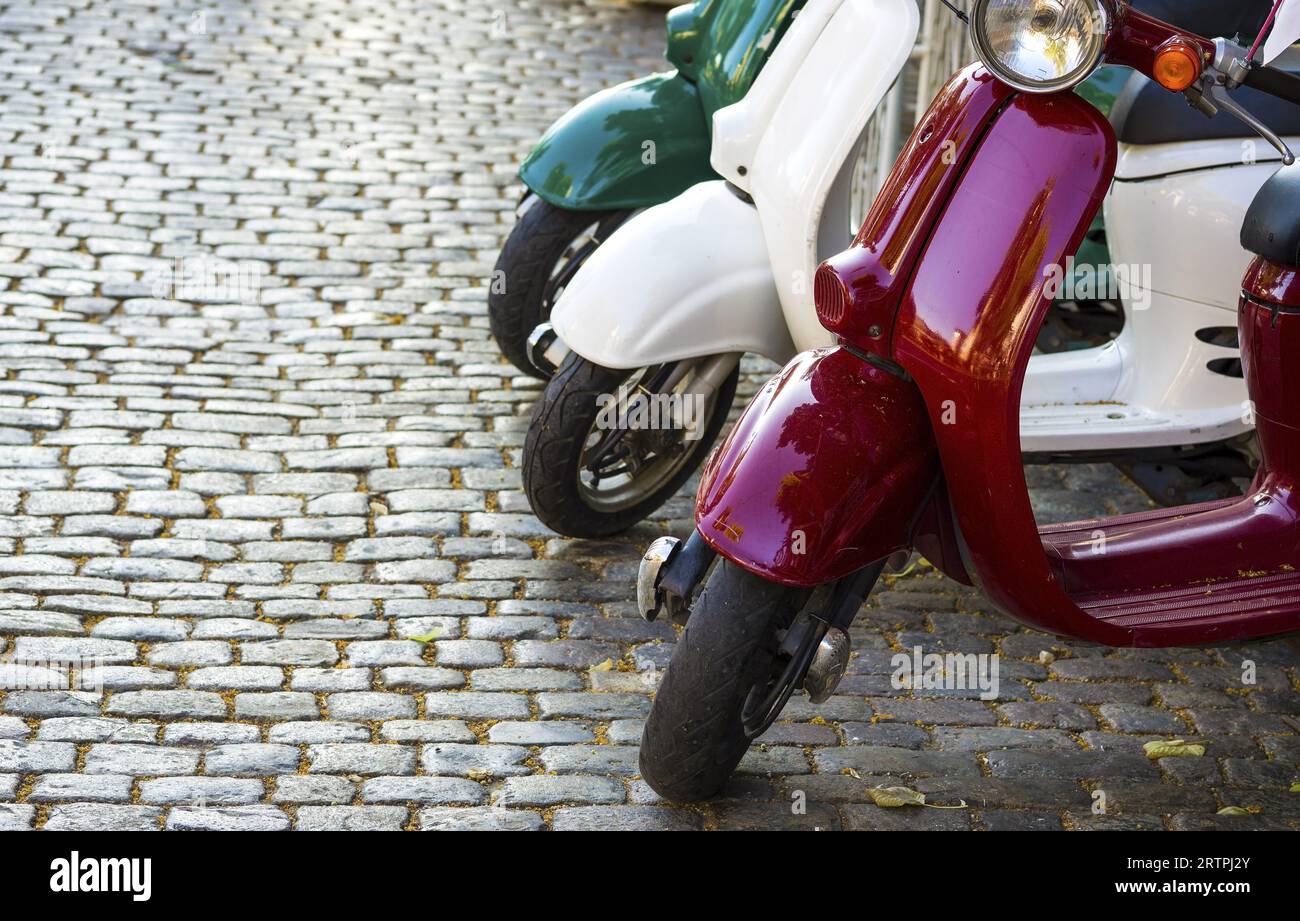 vintage scooters parked on sidewalk. Vintage scooters on a city street ...