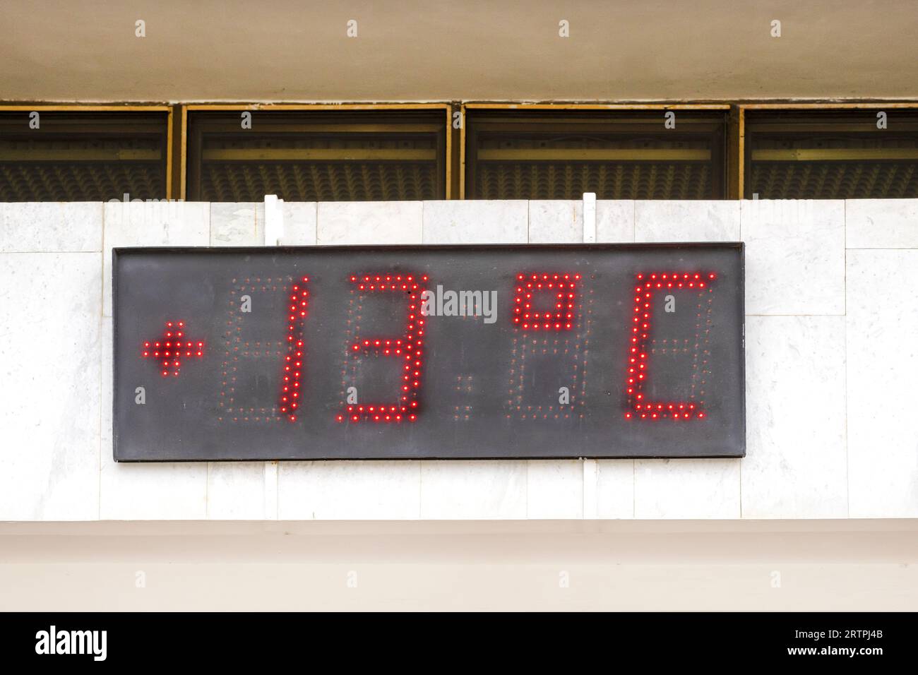 LED DISPLAY on a building facade. LED display shows the temperature ...