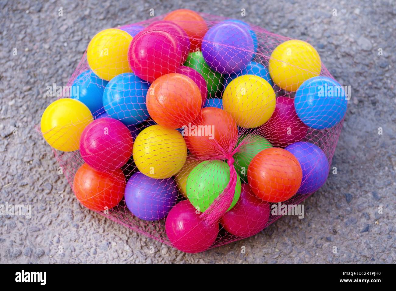 Color plastic toys at the child's legs. Plastic spheres of different ...