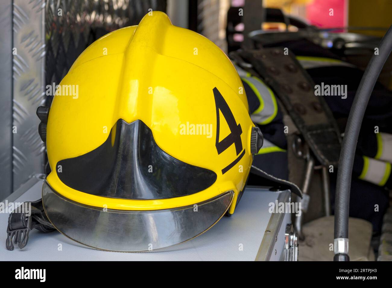 Firefighter uniform with red helmet. Close-up image of a red helmet of ...