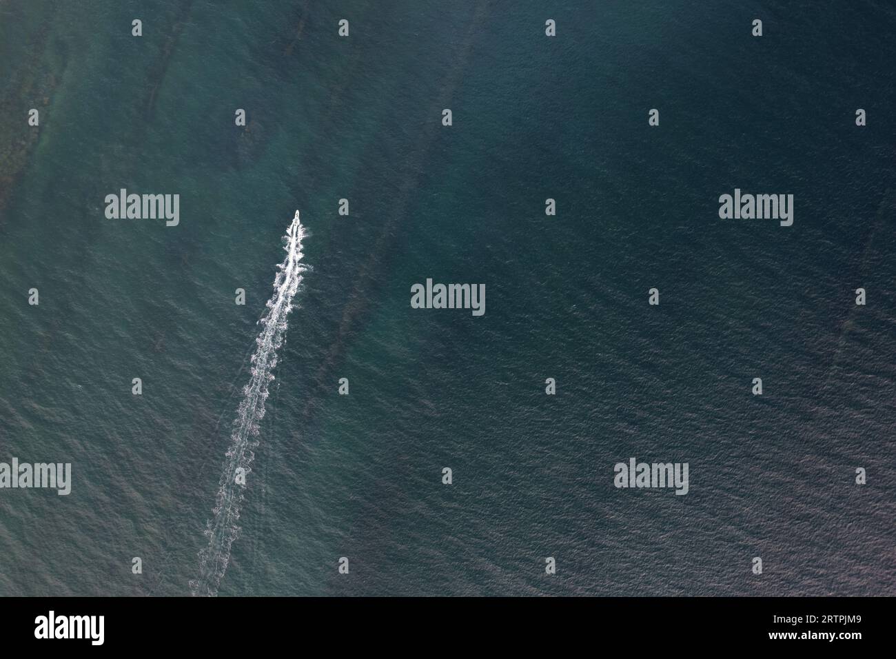 Speed boat moving in shallow water above top view Stock Photo - Alamy