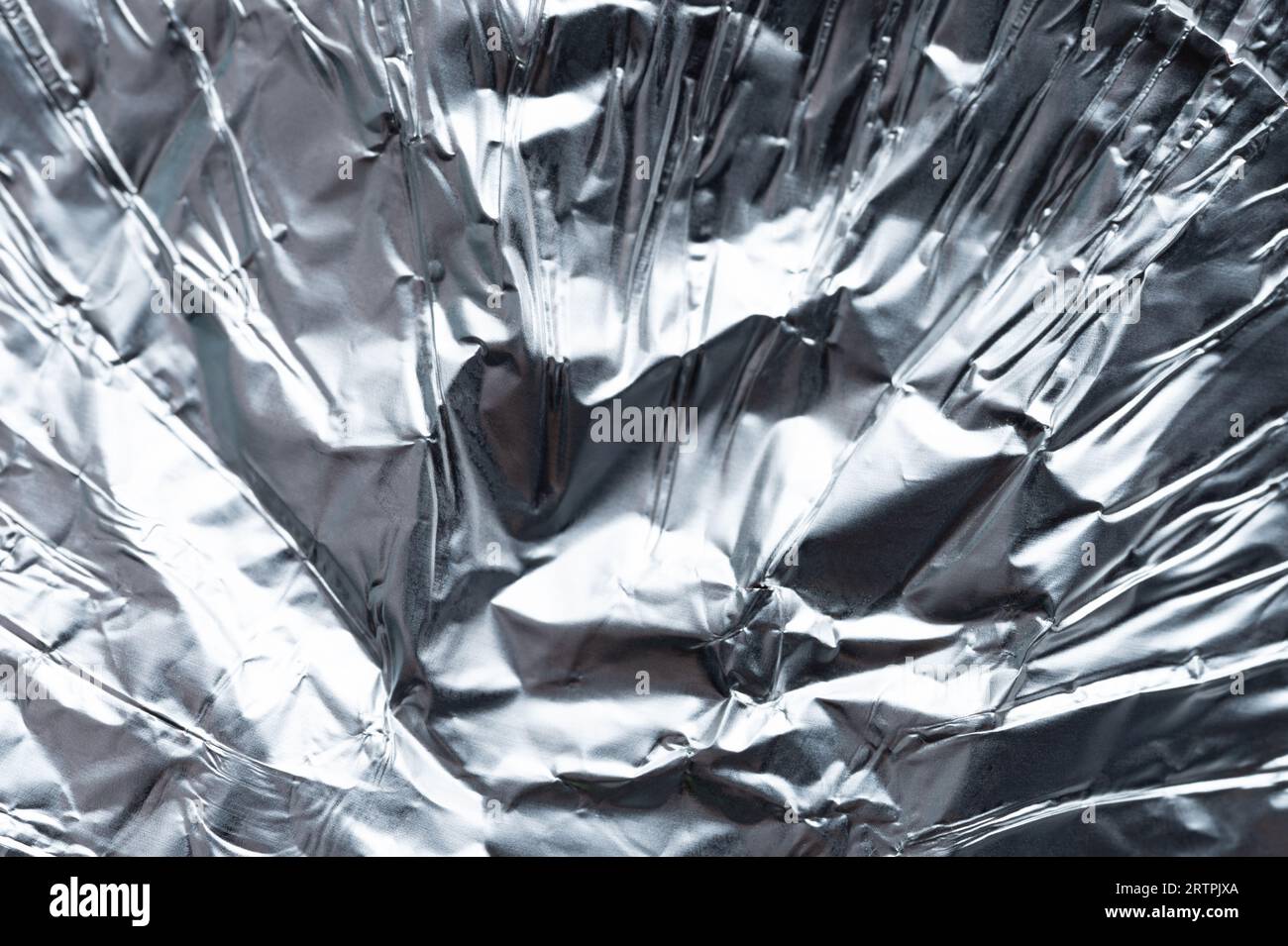 Bright shiny metal background. Crumpled foil texture close up view ...
