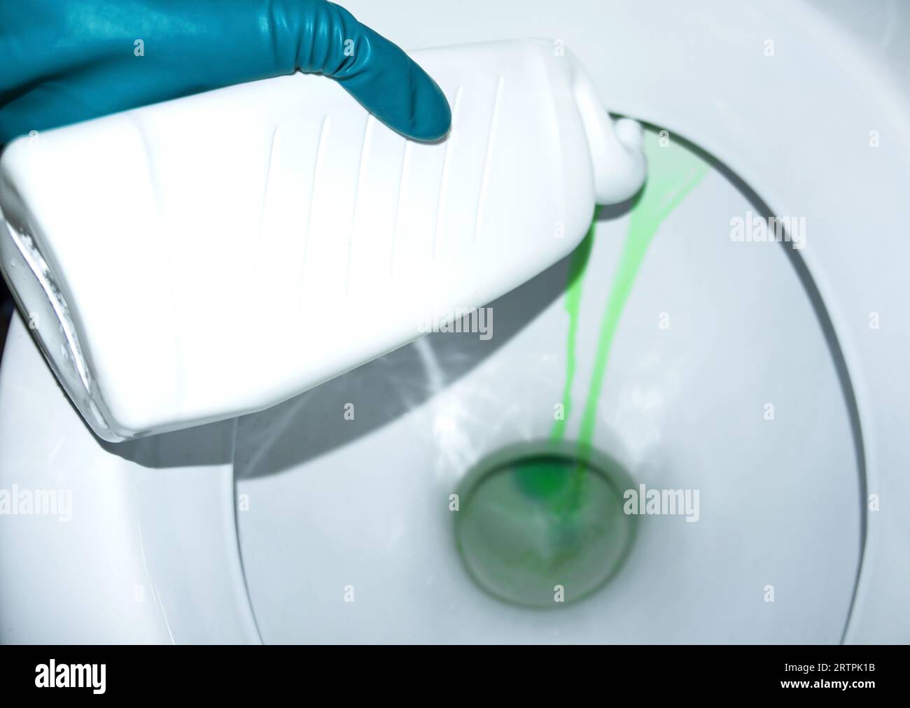 Process toilet disinfectant. Close-up. Hand holds a bottle. Purity in a ...