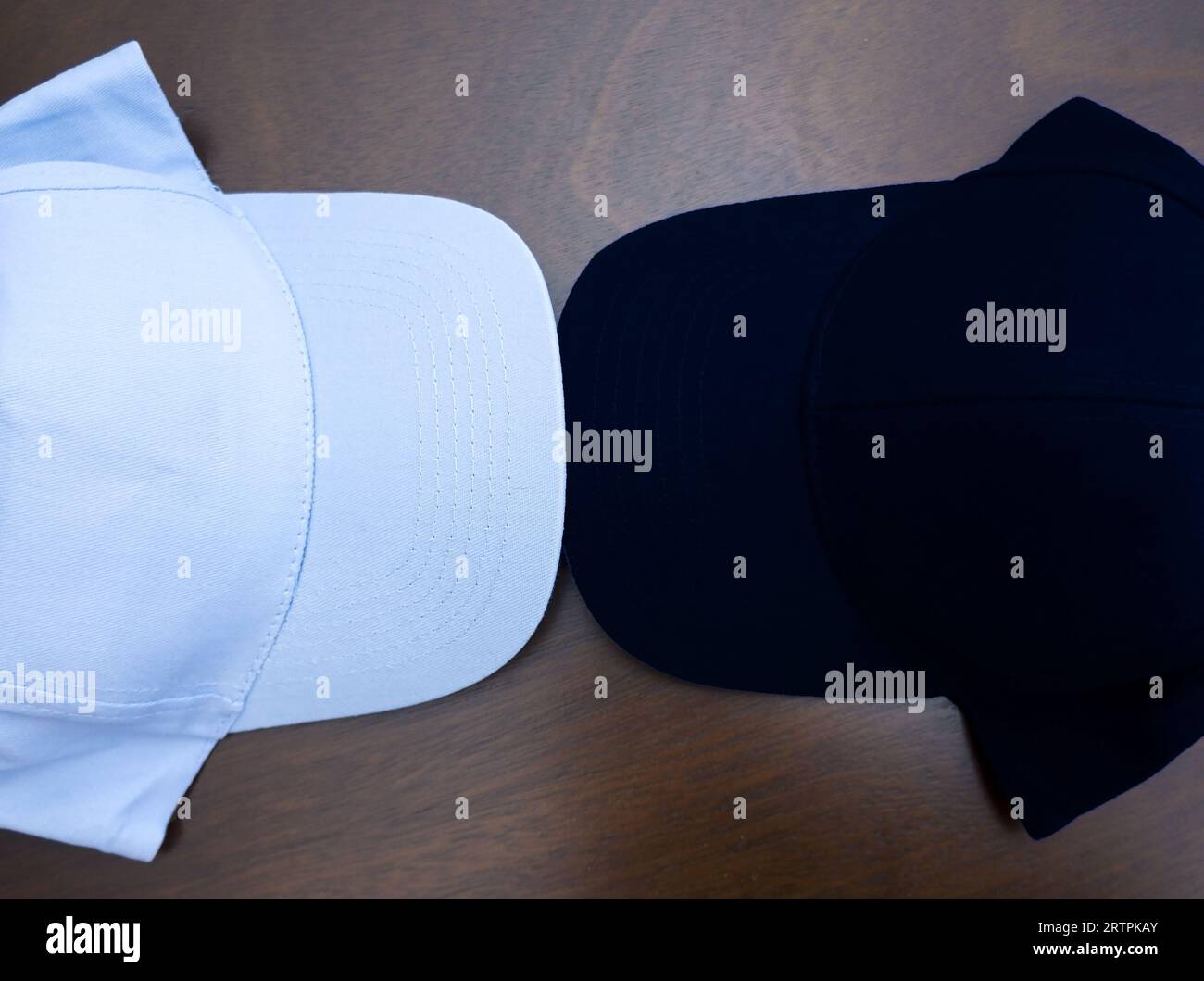 Two headdresses, caps of different color. dark and white baseball cap ...