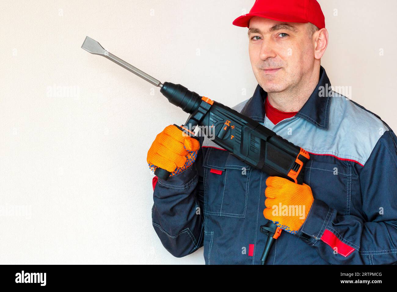 workman with a rotary hammer. worker, professional with hammer drill ...