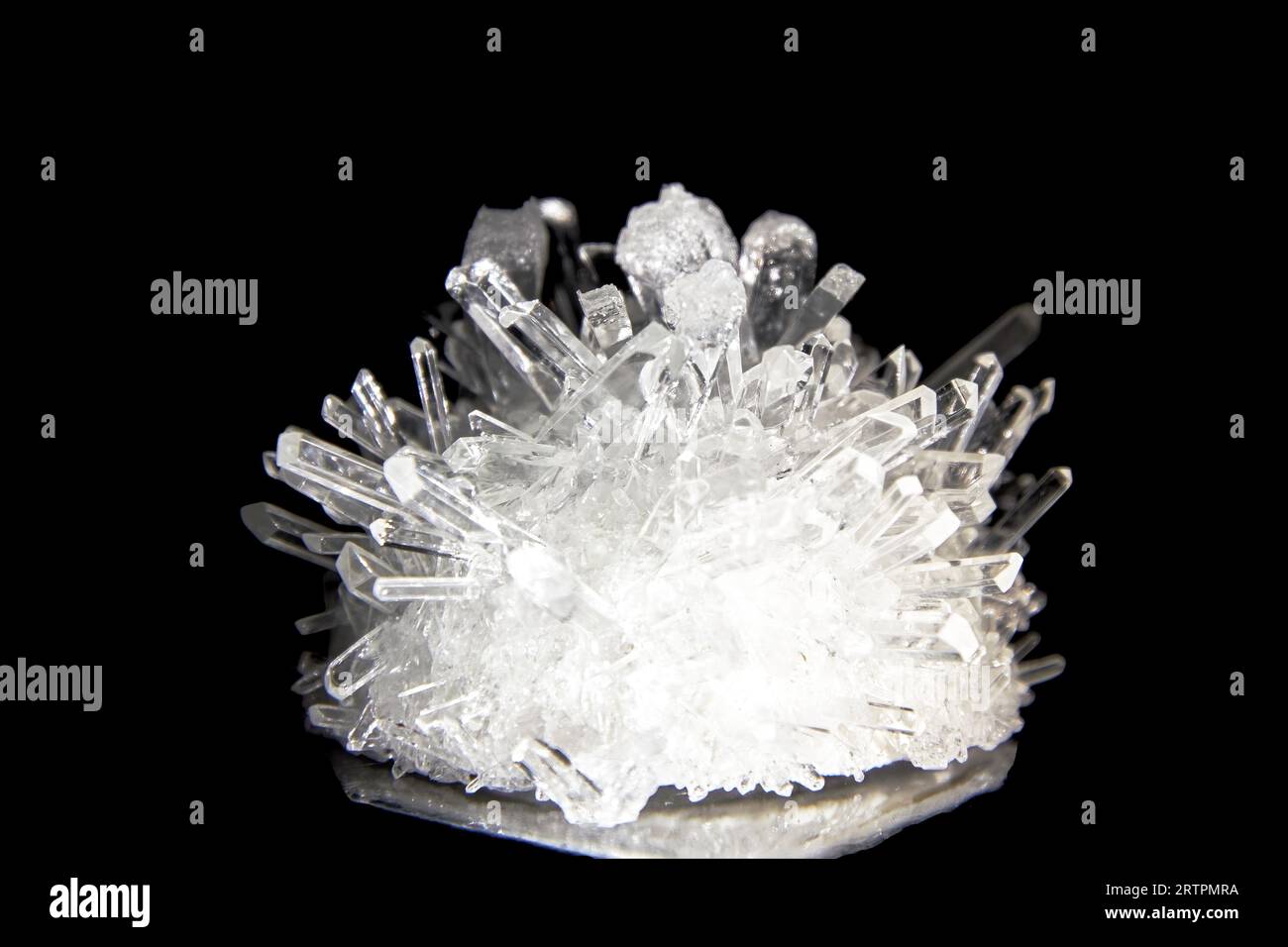 Shiny white sharp quartz crystal highlighted and isolated on black ...