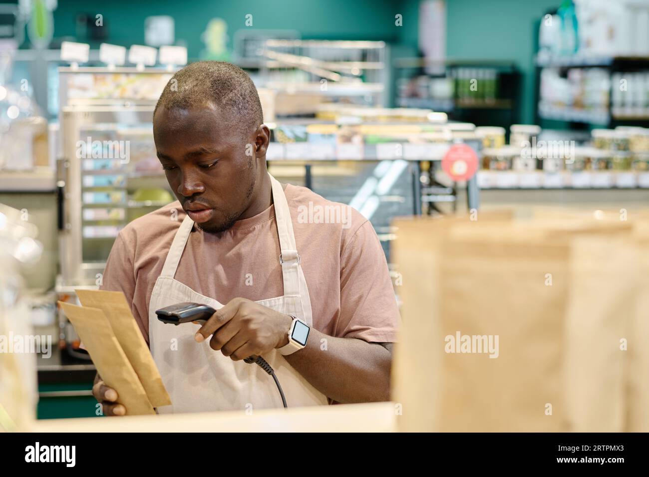 African American worker scanning barcodes of goods with scanner during ...