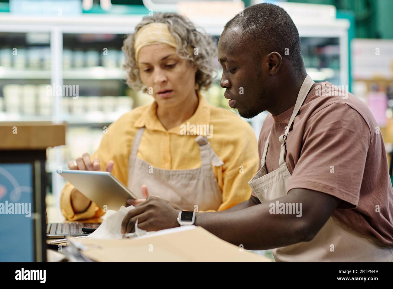 Colleagues making an audit using digital tablet during their teamwork ...
