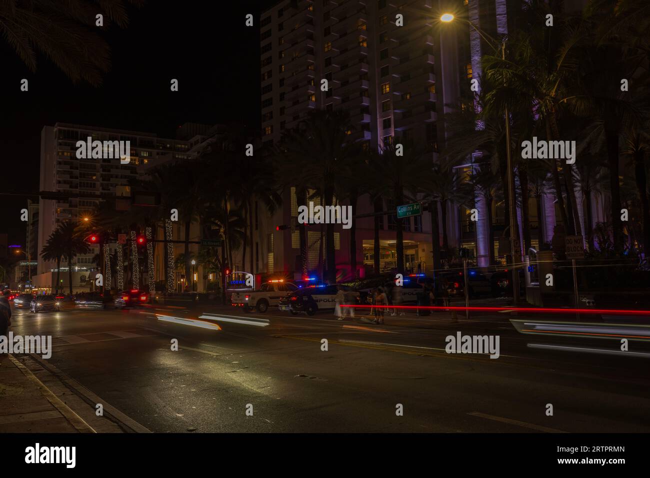 Night view of Miami Beach cityscape with police cars and defocused ...