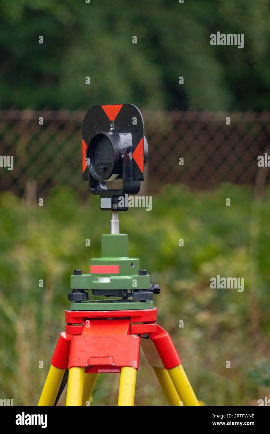 Surveyors with instruments on railway track near fresh green forest in ...